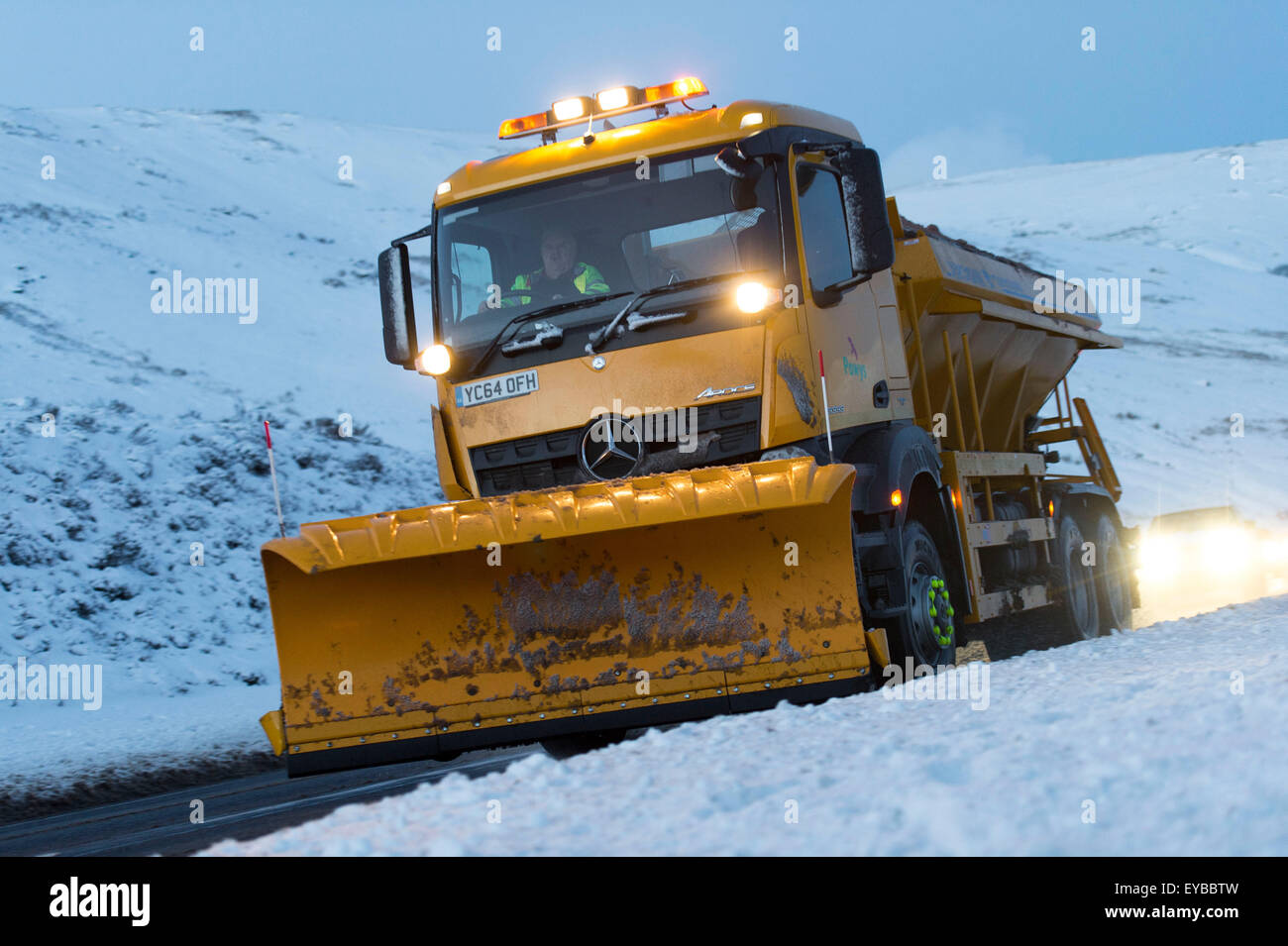 A snowplough and gritter clears snow and ice from a frozen A470 in ...