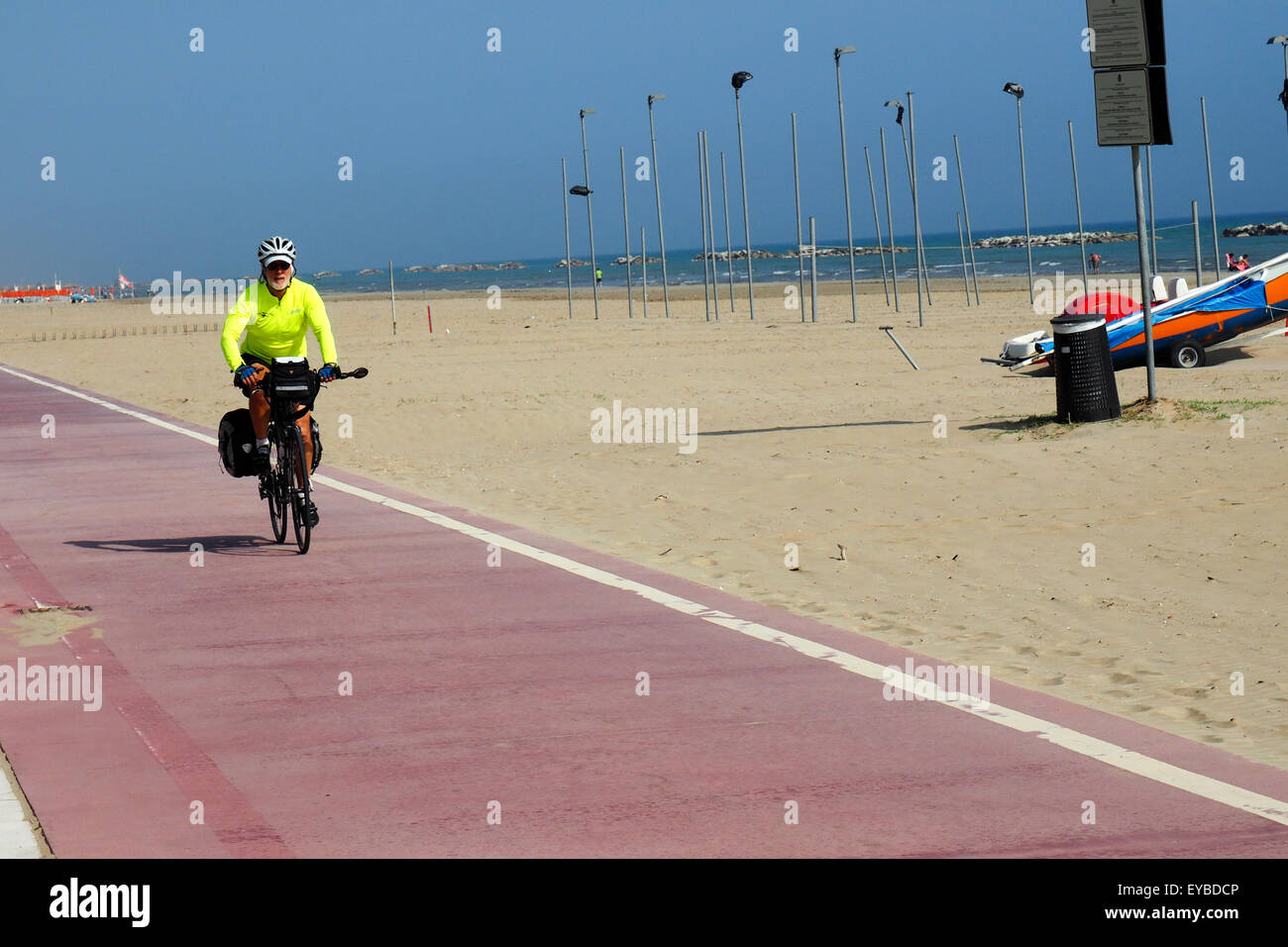 Touring cyclist cycling on a bike path on the beach Stock Photo - Alamy
