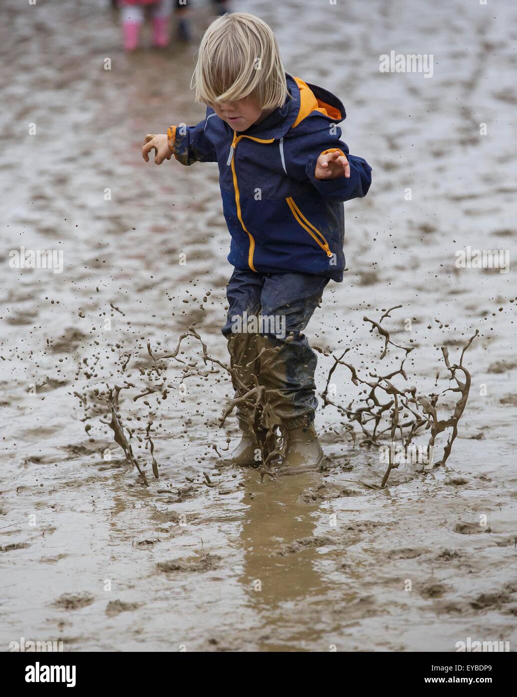 Malmesbury, Wiltshire, UK. 26th July, 2015. A young boy jumps in the ...