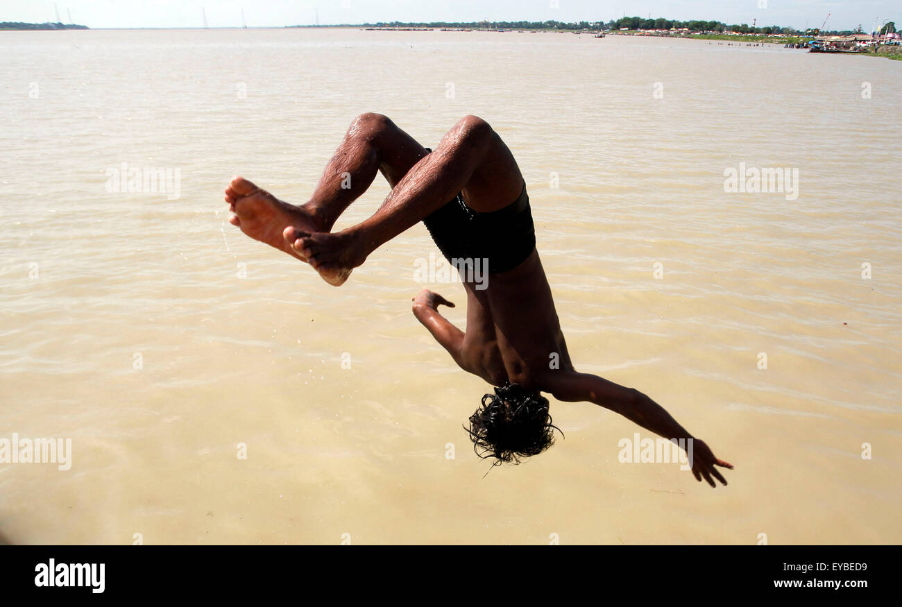 Allahabad, India. 26th July, 2015. Boys jump in the flooded water of ...