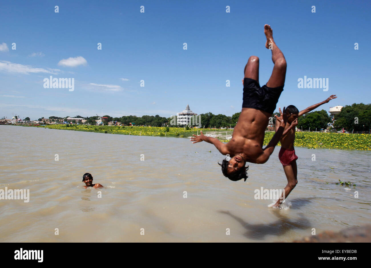 Allahabad, India. 26th July, 2015. Boys jump in the flooded water of ...