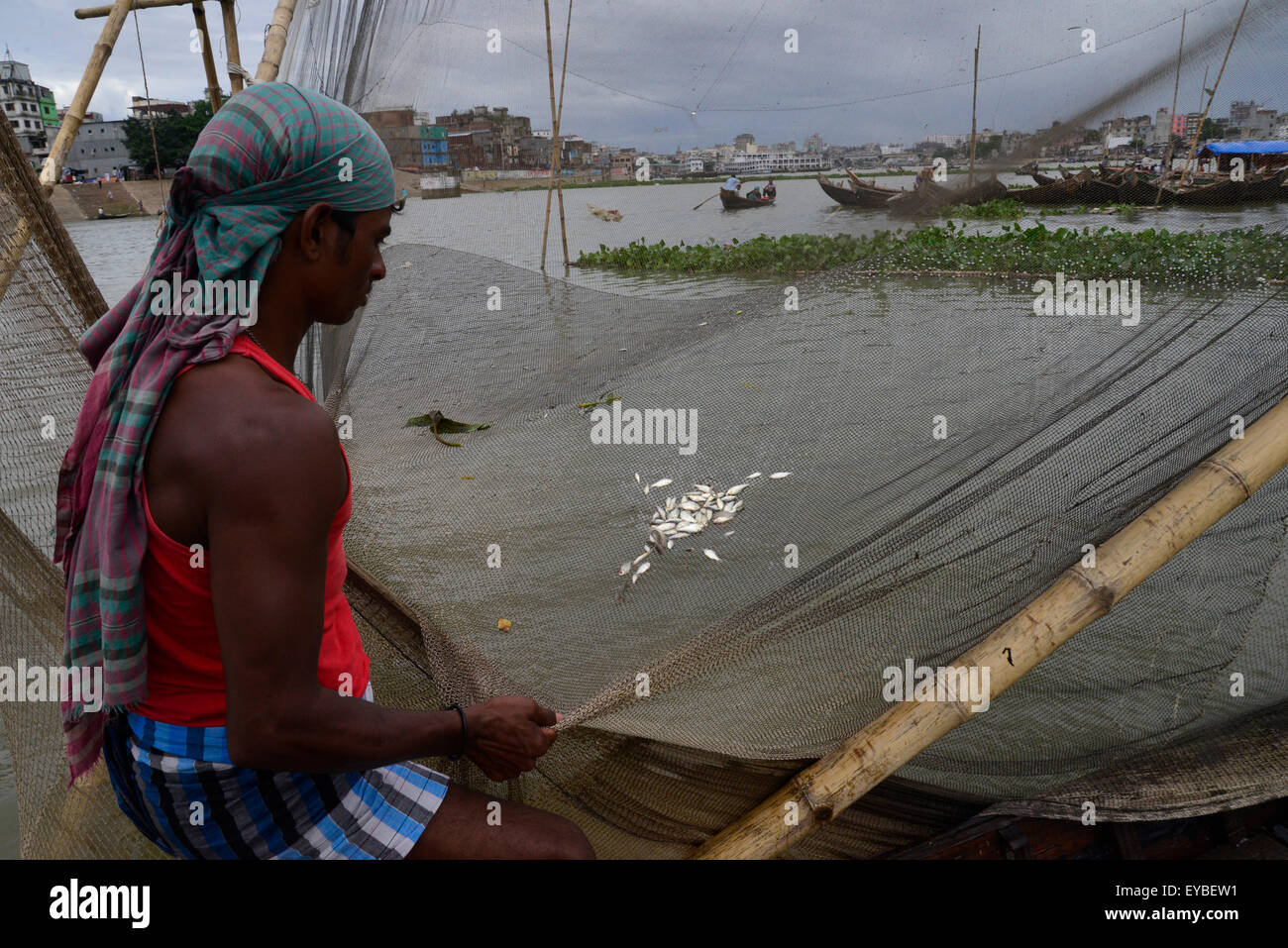 Dhaka, Bangladesh. 26th July, 2015. A Bangladeshi fisherman busy to ...