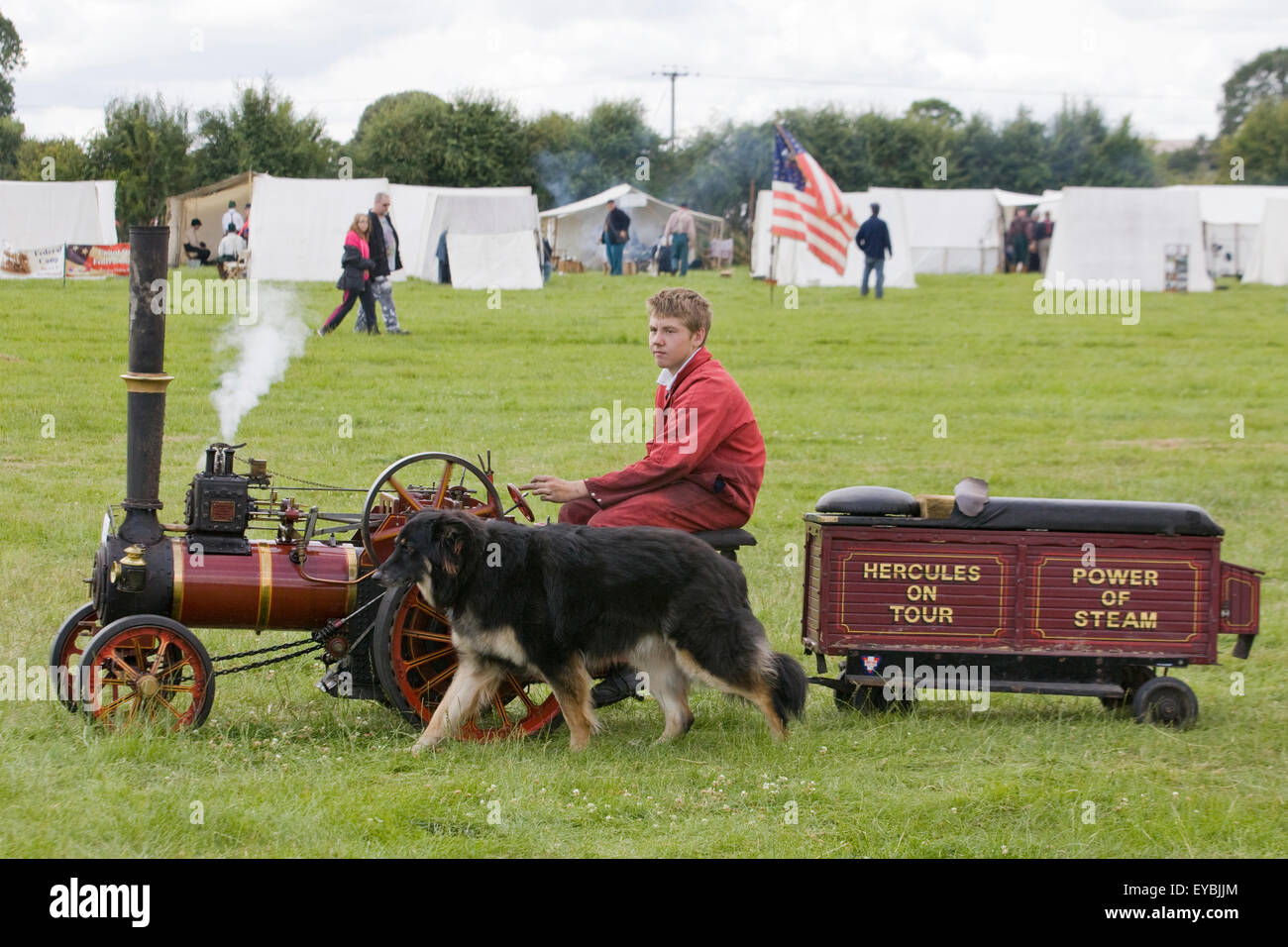 Miniature Steam Engine with Dog along side of it Stock Photo - Alamy