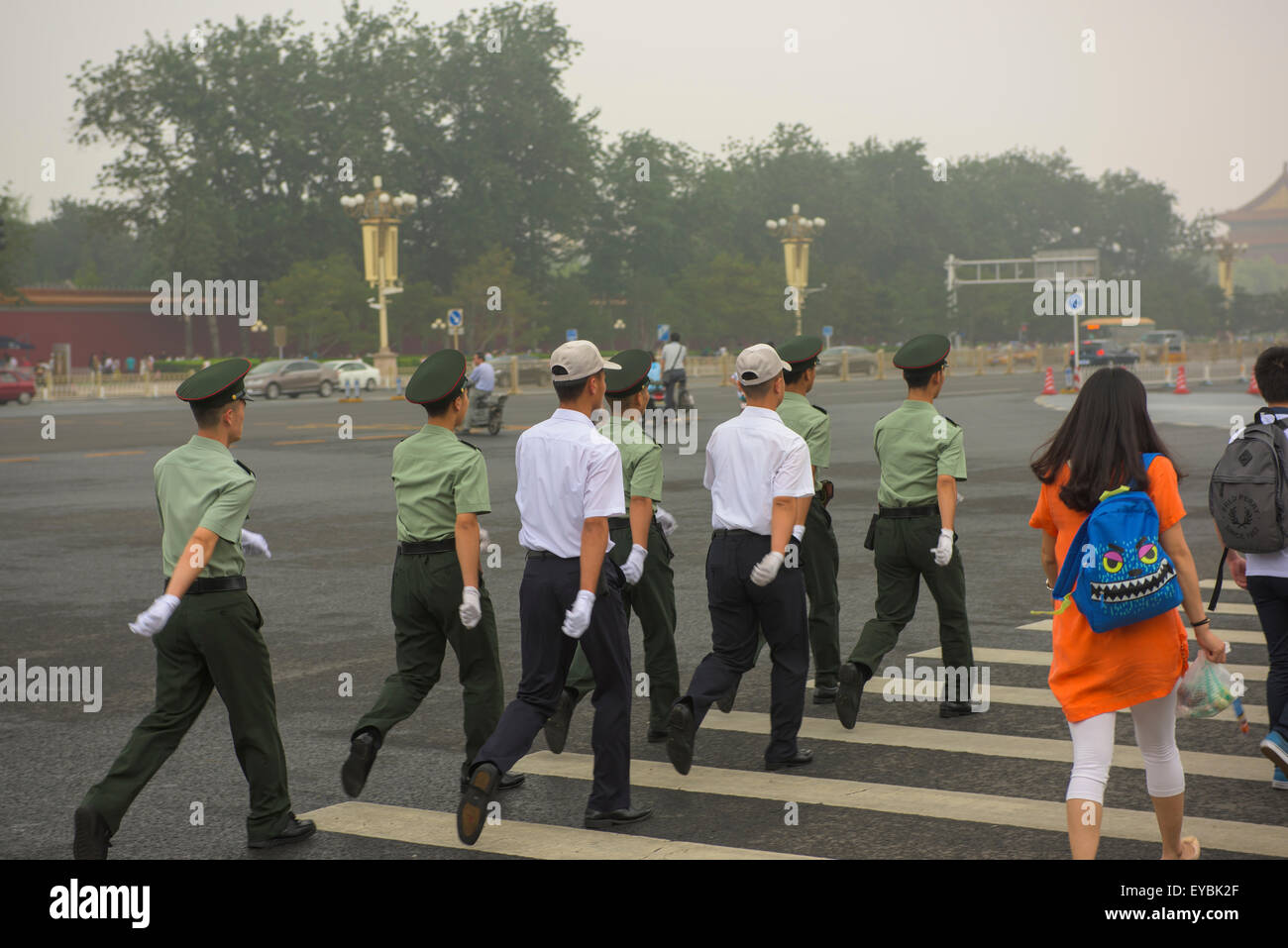 Chinese policemen crossing the road near Beijing's Tiananmen Square ...