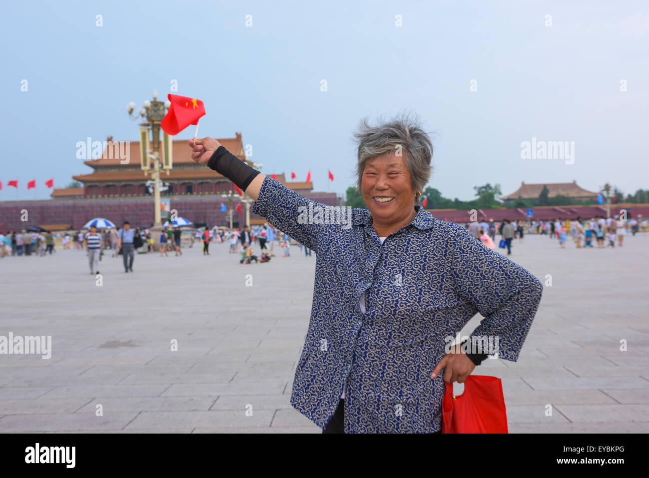 Chinese lady flying the flag on a visit to Tiananmen Square, Beijing ...