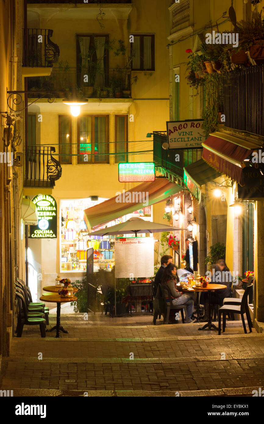 Cafe at night in Taormina in Sicily, Italy Stock Photo - Alamy