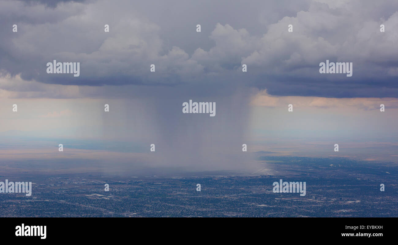 Rain pours onto Albuquerque Airport from clouds over the city. View as ...
