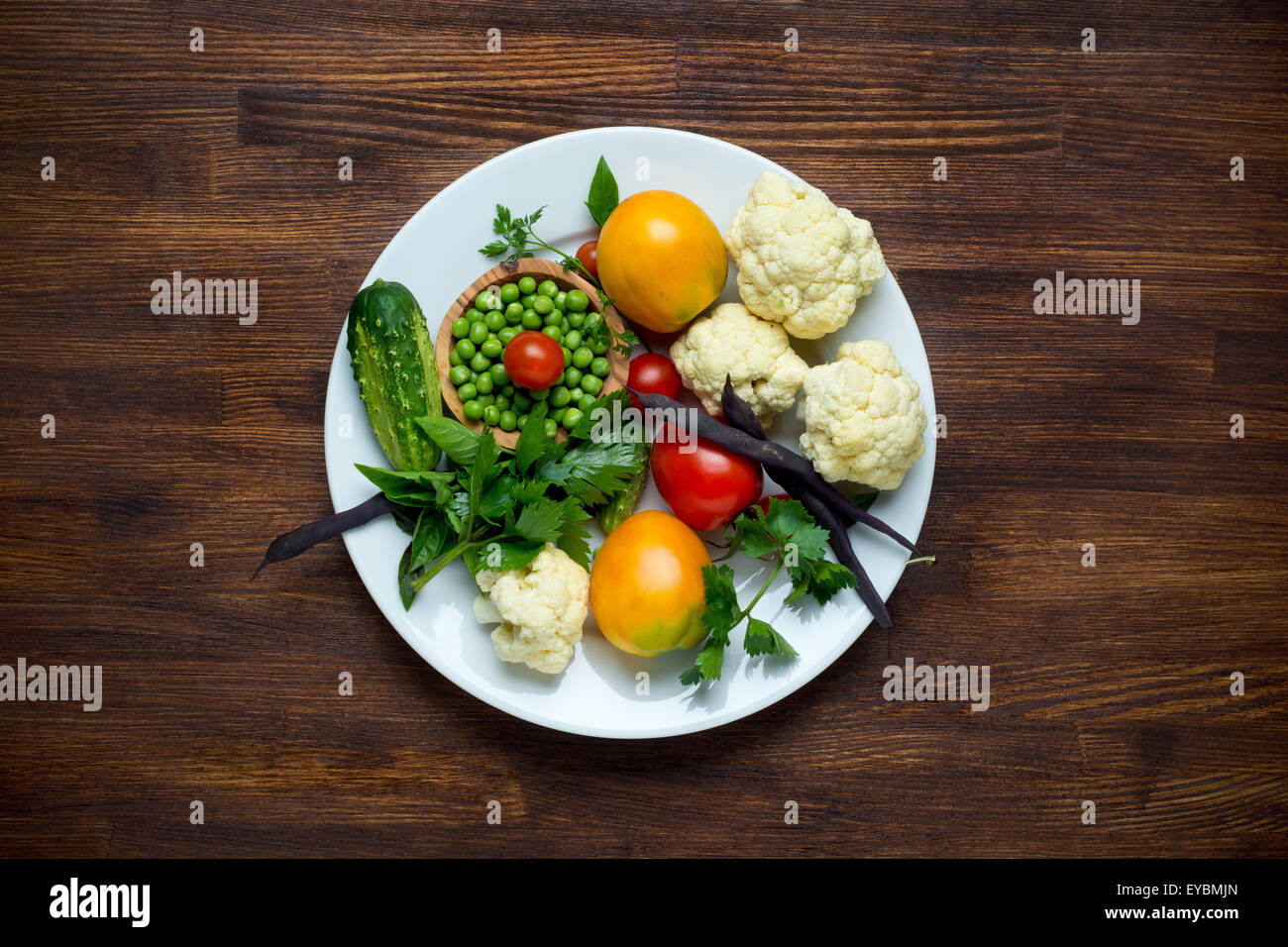 Photo of white plate with fresh vegetables. Top view Stock Photo - Alamy