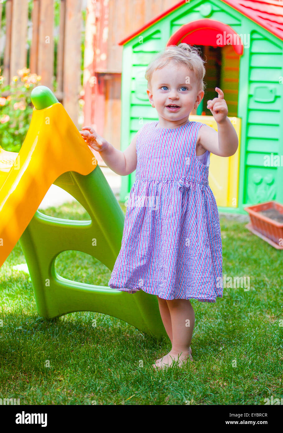 Portrait of 1 year old baby girl playing at home with the slide Stock ...
