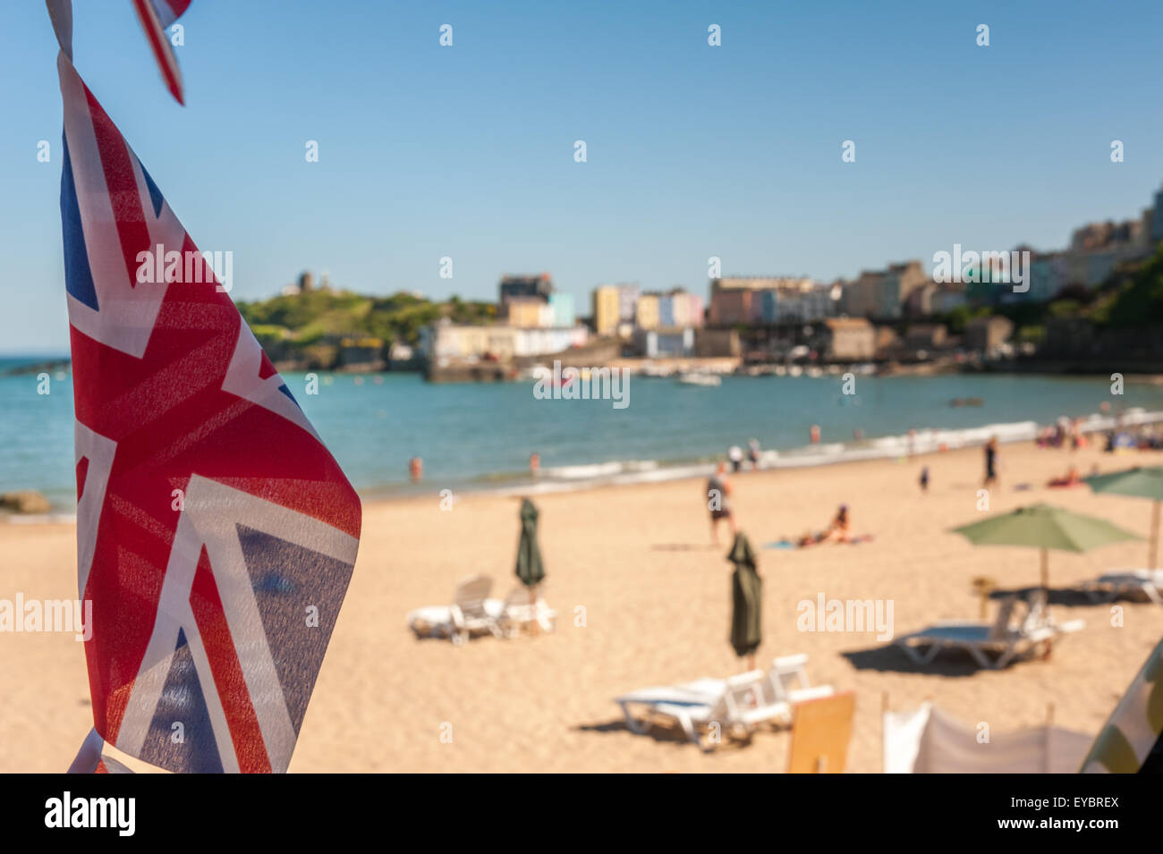 A colourful pennant featuring the Union flag flaps in a breeze in Tenby ...