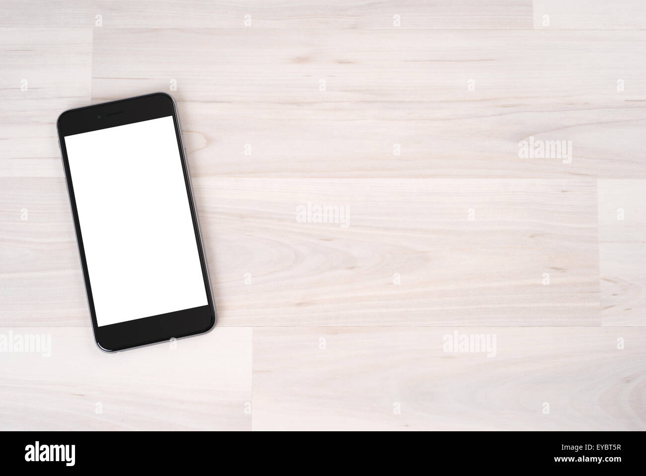 Smartphone on wooden table on light background Stock Photo - Alamy