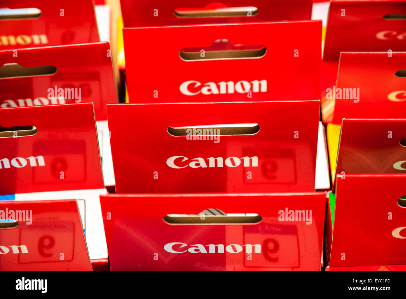 Canon printer ink boxes each housing a color ink cartridge. Several ...