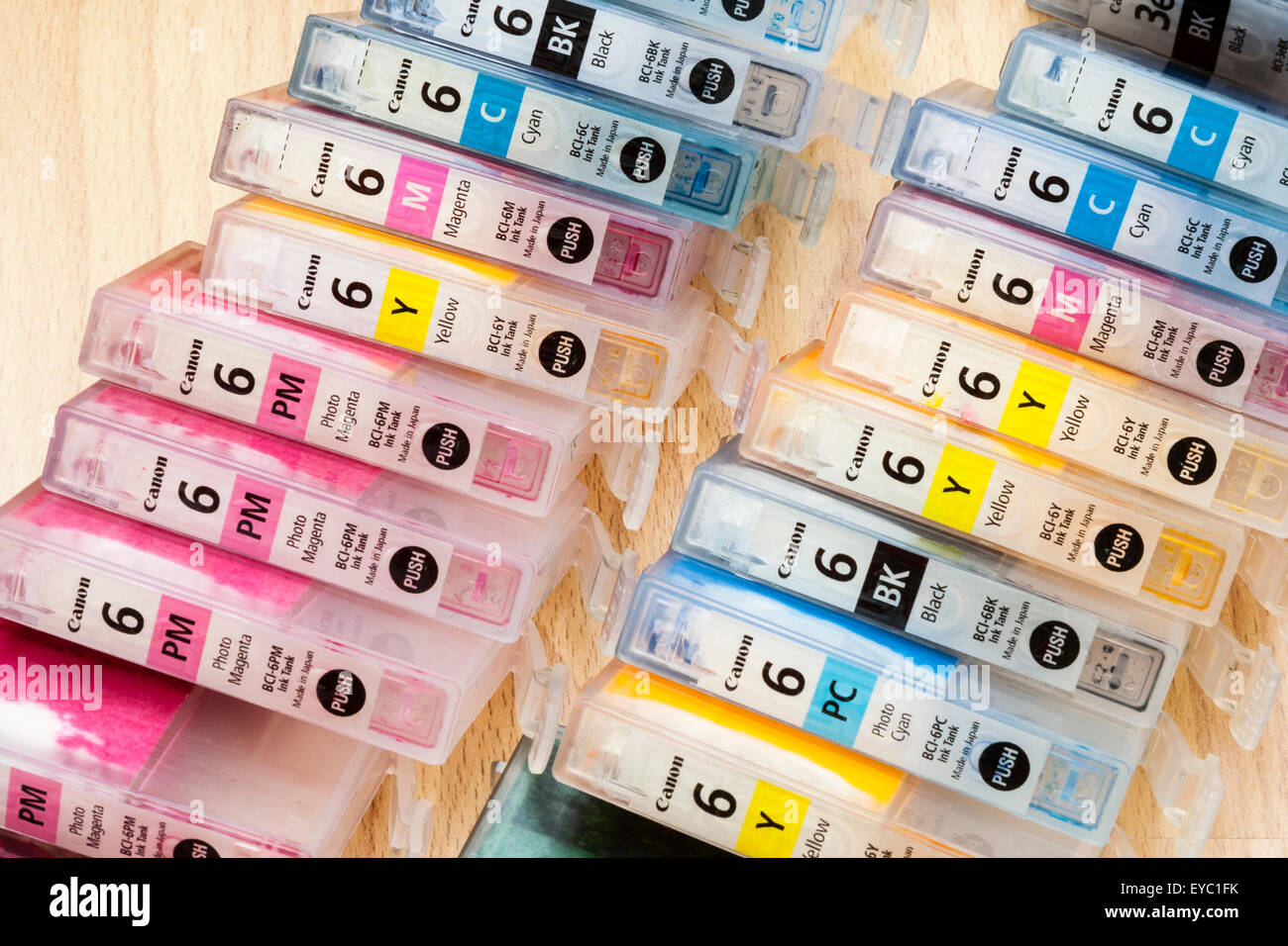 Scattered empty used ink jet printer cartridges of various colored inks ...