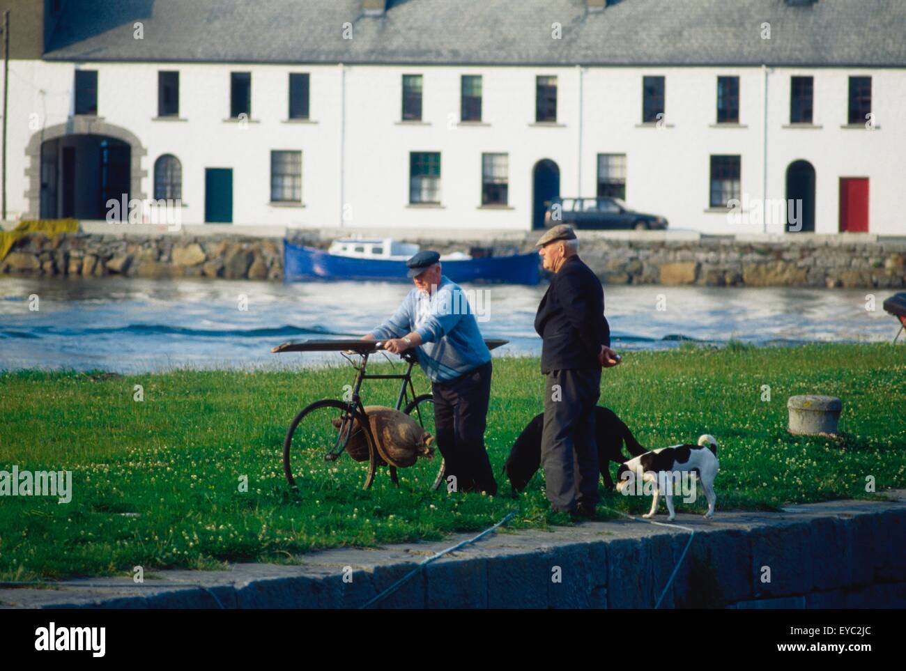 Galway Harbour, Galway, Co Galway, Ireland; Two Men In A Village Stock ...