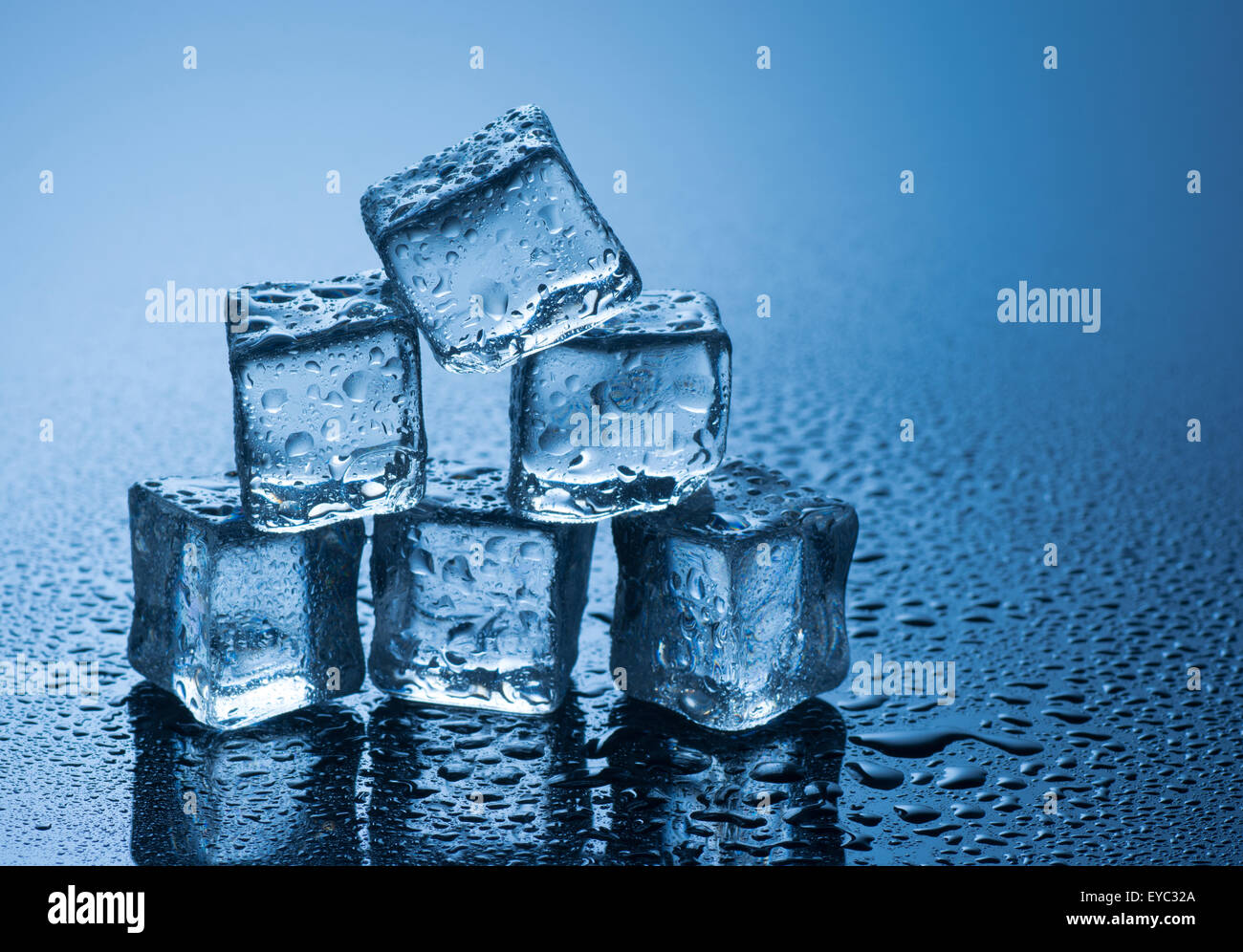 wet ice cubes on blue background Stock Photo - Alamy