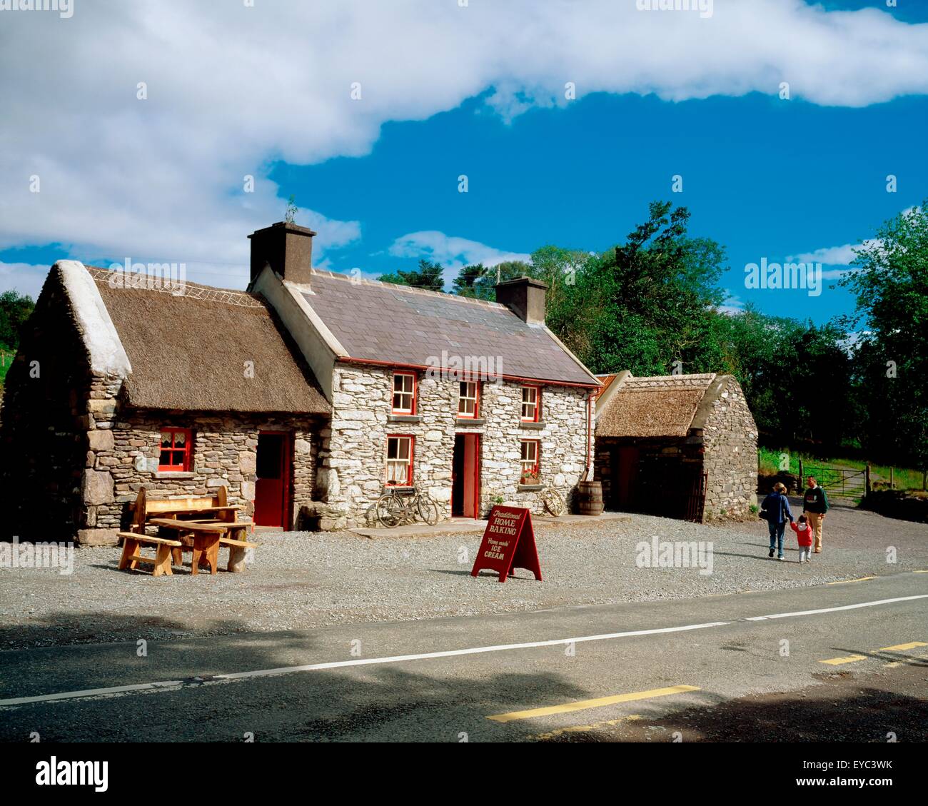 Traditional Farm, Co Kerry, Ireland; Family Walking By A Stone Cottage ...