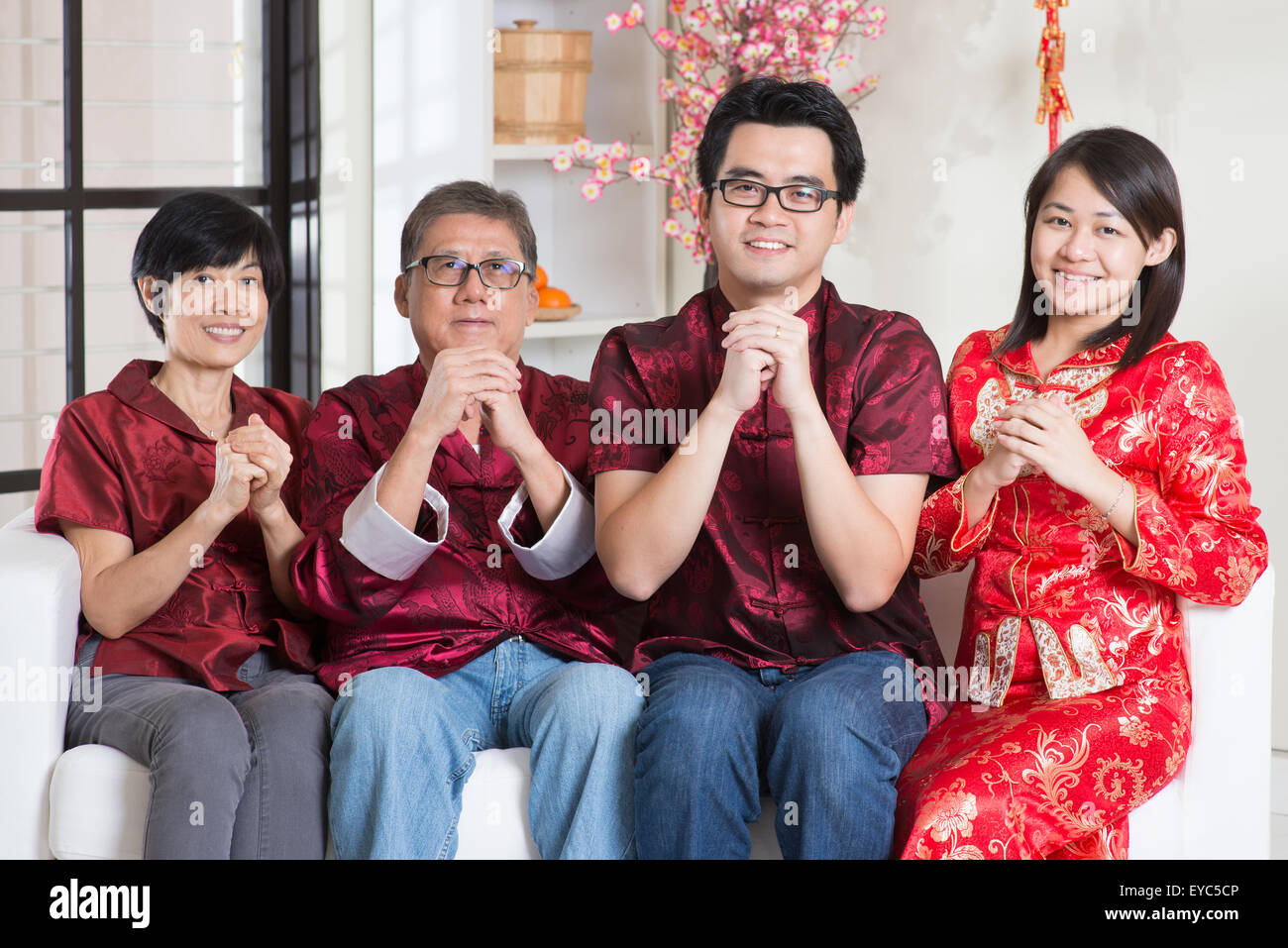 Happy Chinese new year. Happy Asian family in red cheongsam reunion and ...