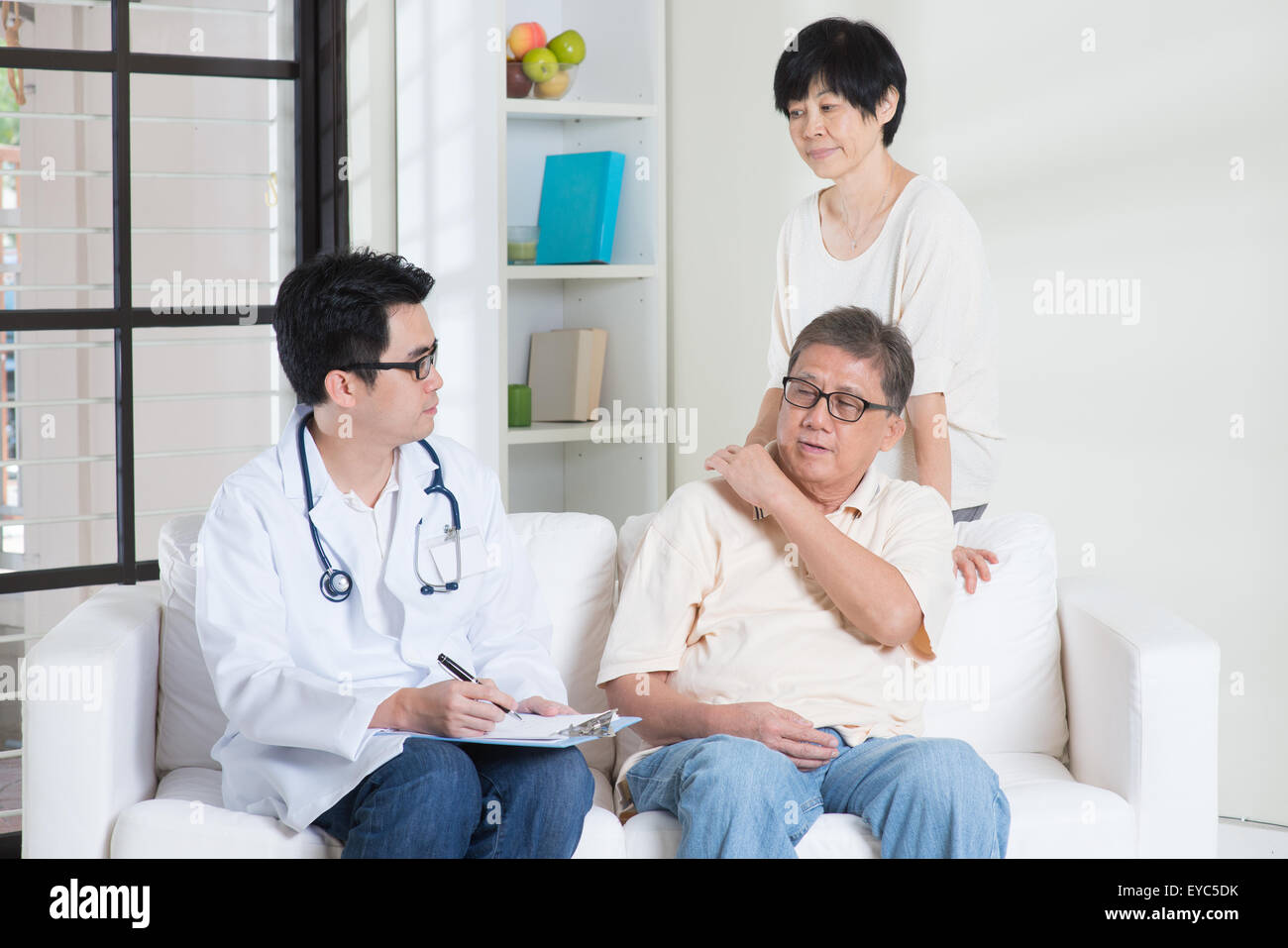 Asian Family Doctor Male Asian Doctor Examining Senior Woman Patient