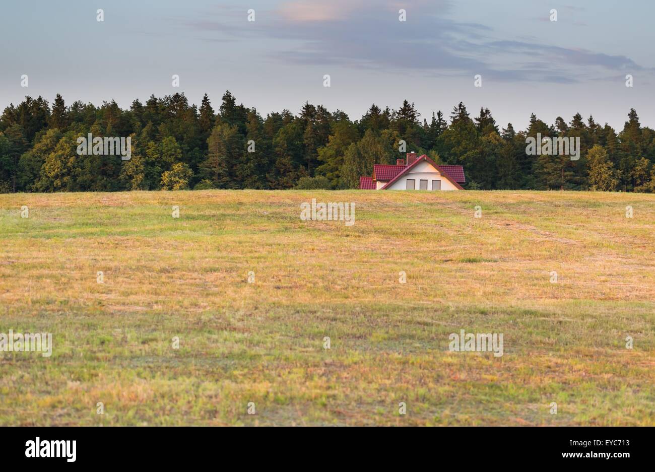 Part of modern house behind the hill on rural countryside. Landscape ...