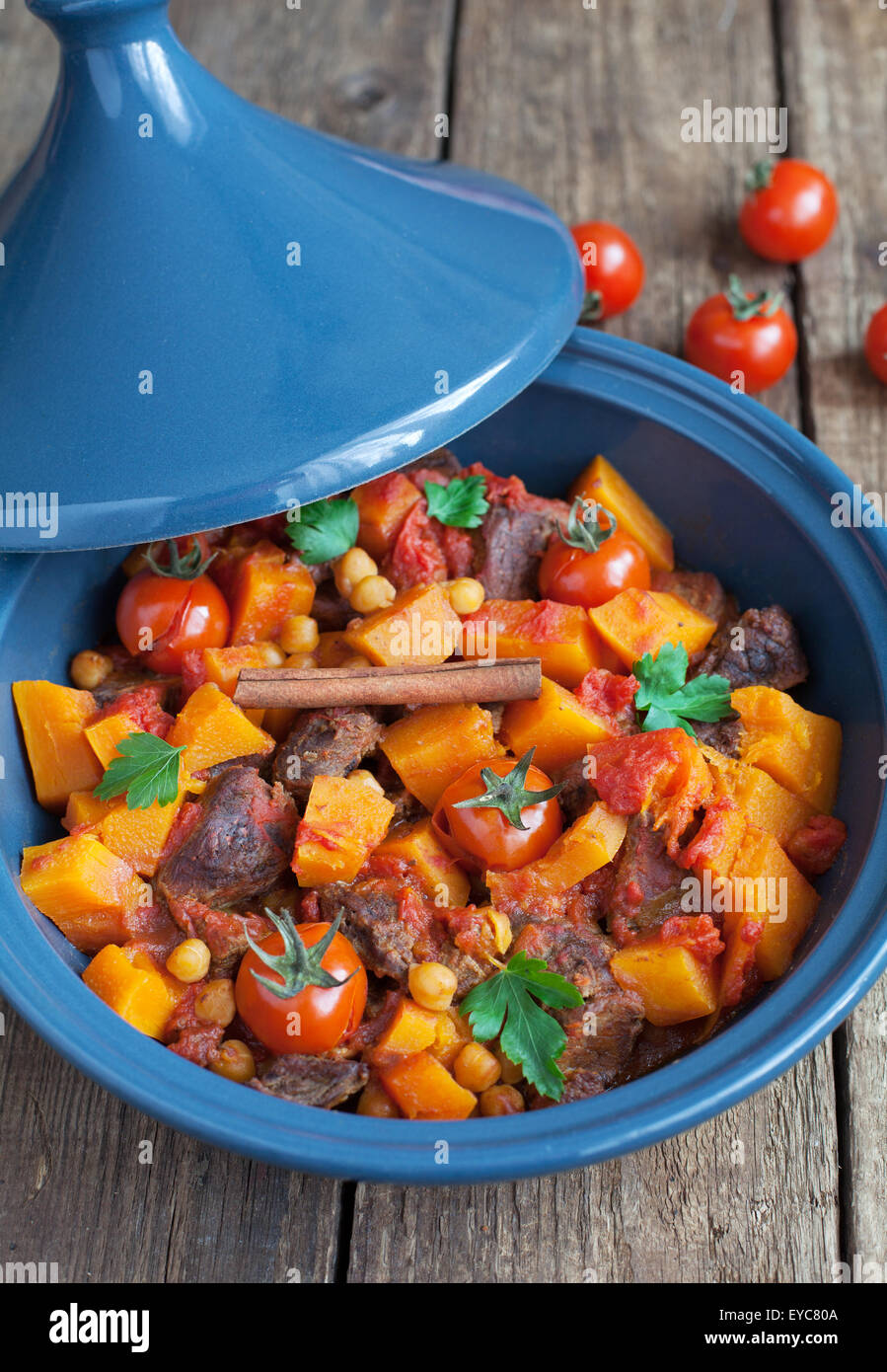 Moroccan Tagine with beef, chickpeas, pumpkin and cherry tomatoes on a ...