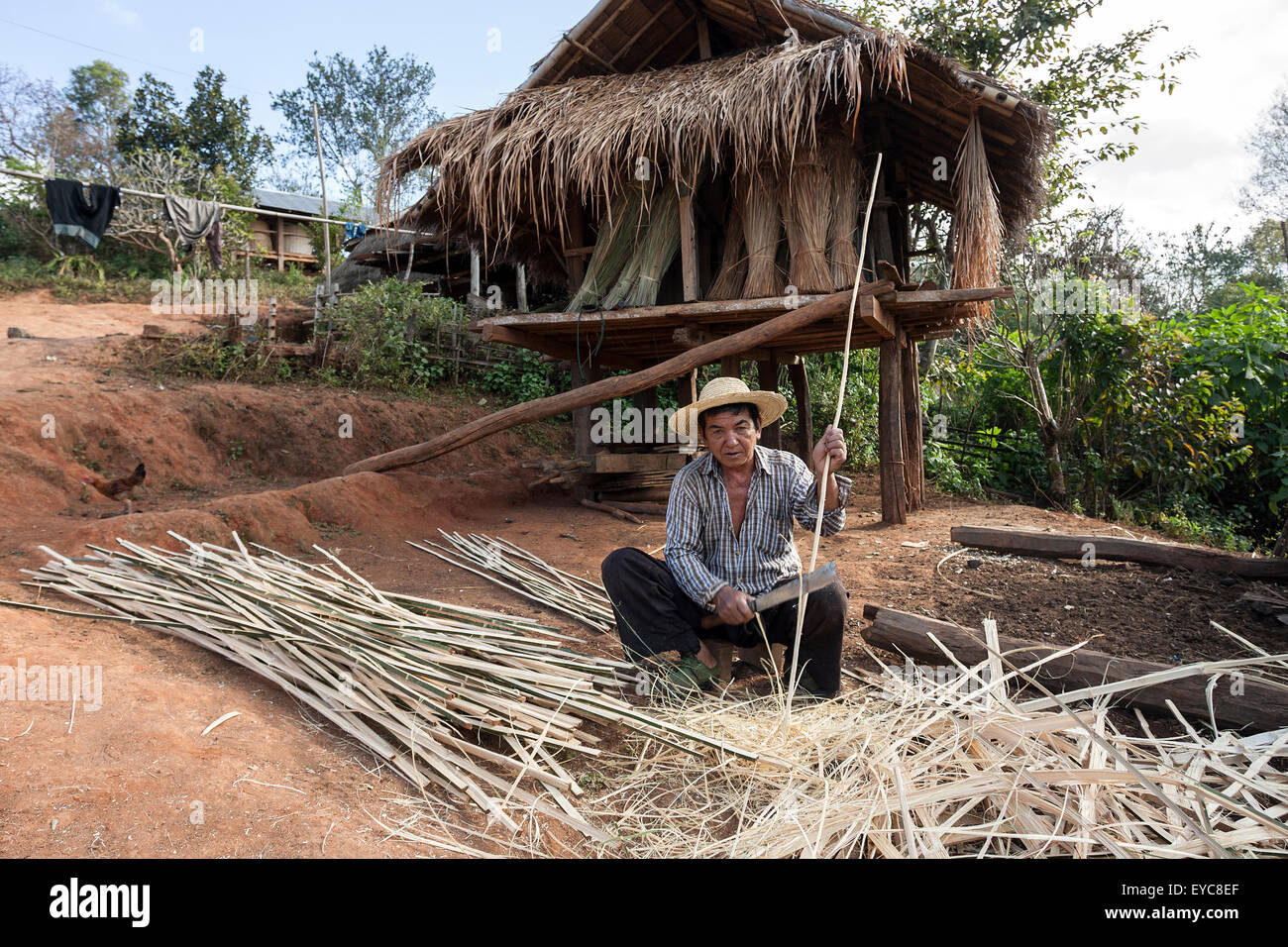 Local man from the tribe of the Akha, working on bamboo sticks, Hokyin ...