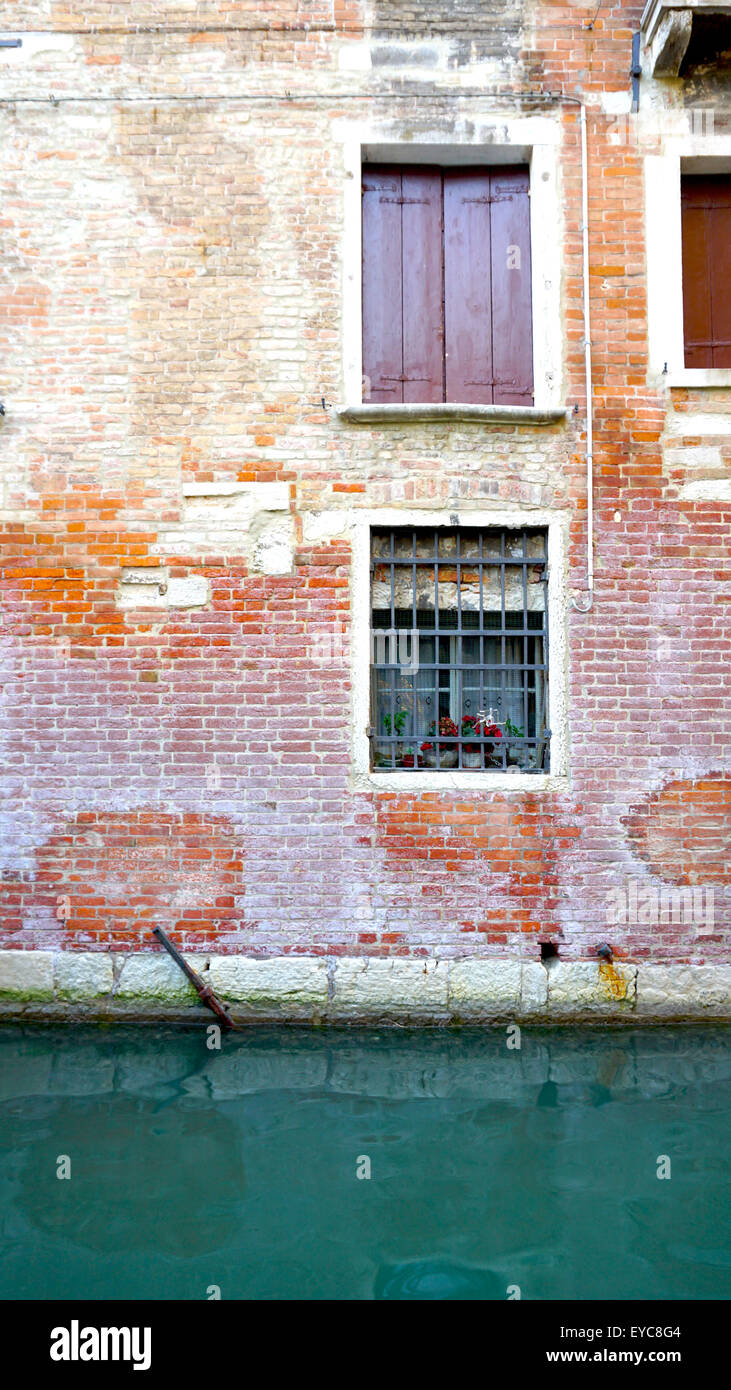 ancient brick wall of building and canal in Venice, Italy Stock Photo ...