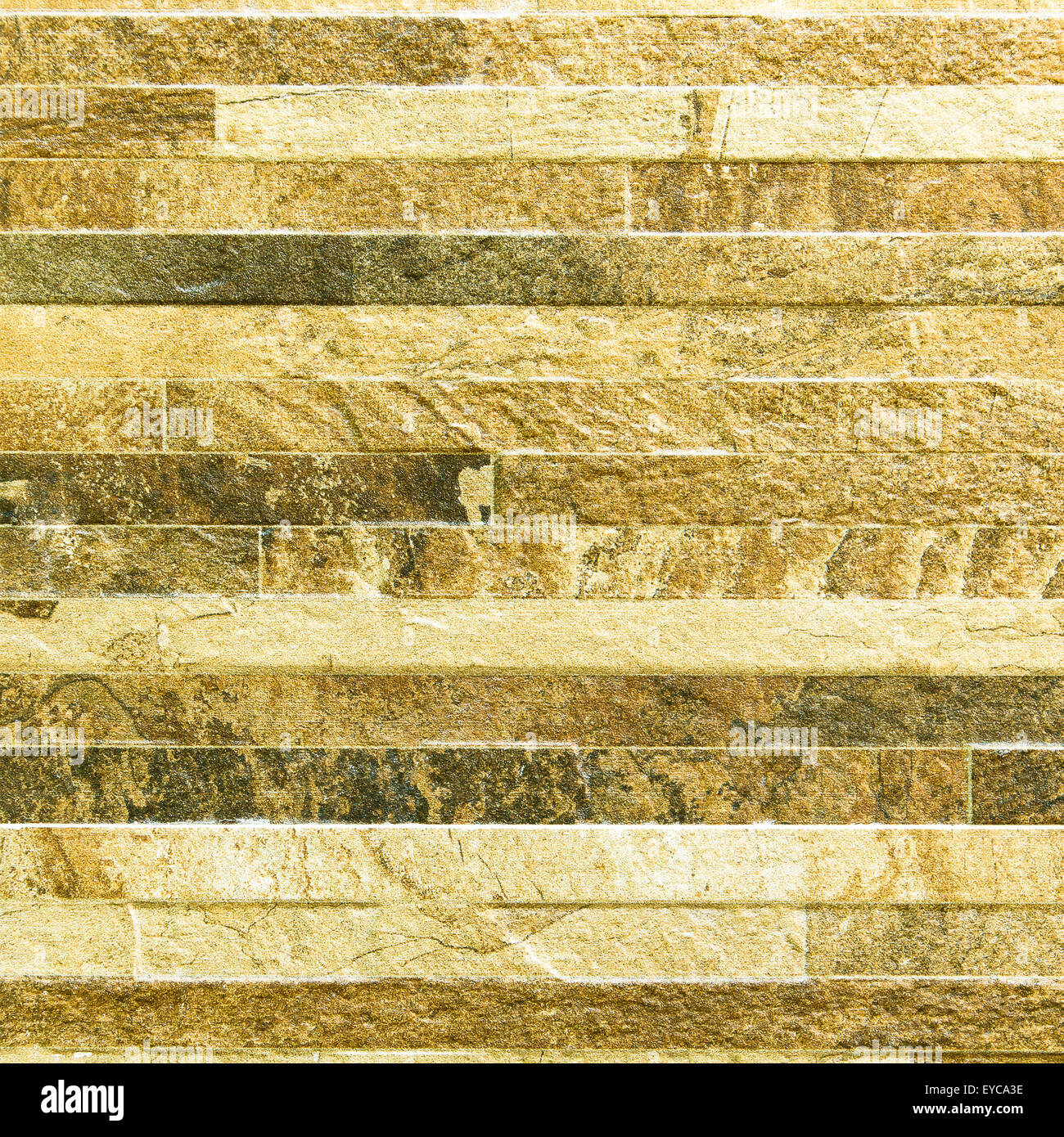 Gold stacked stone wall texture. A brick layer building a brick wall ...