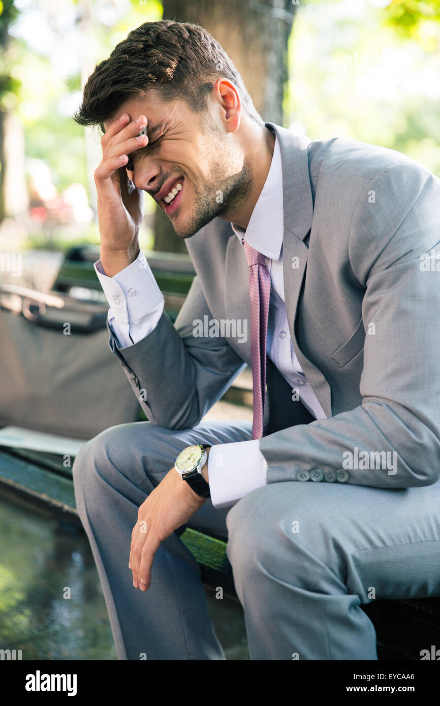 Portrait of depressed businessman sitting on the bench outdoors Stock ...