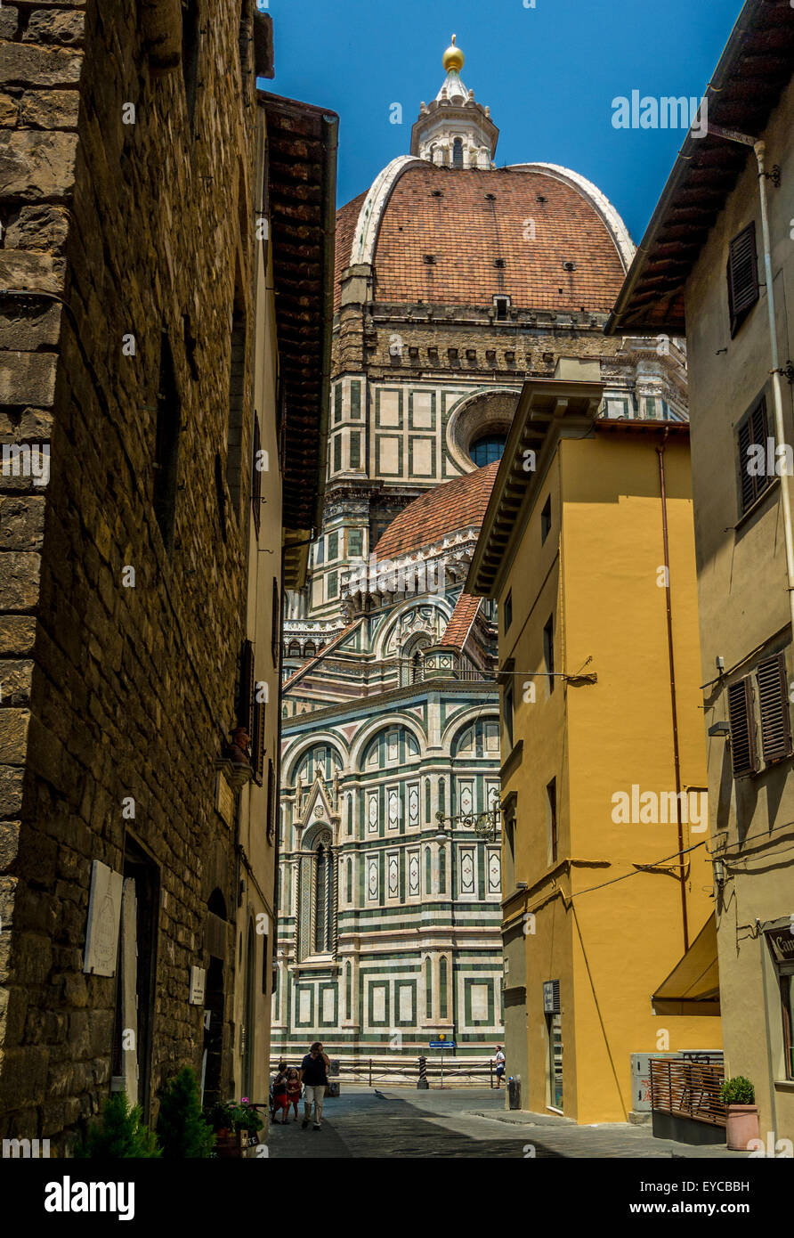 Florence Cathedral glimpsed between buildings in the city of Florence ...