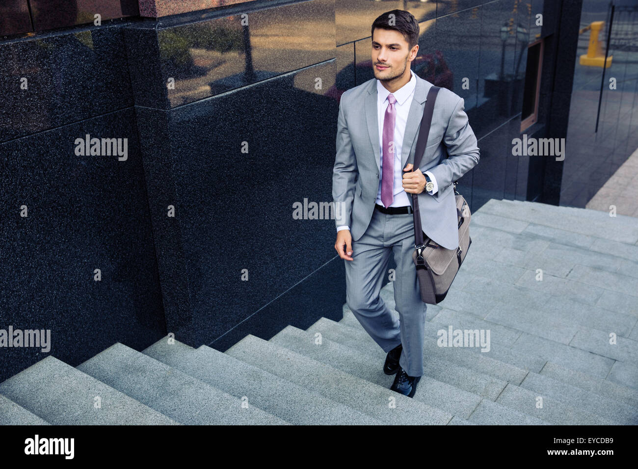 Confident businessman walking on stairs outdoors Stock Photo - Alamy