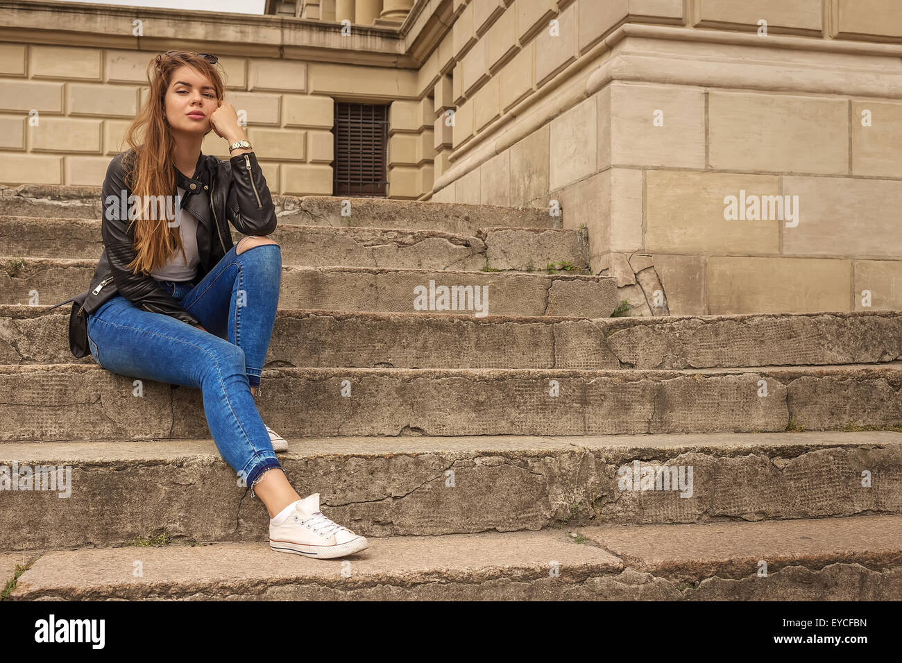 Portrait of a serious woman thinker sitting on steps Stock Photo - Alamy