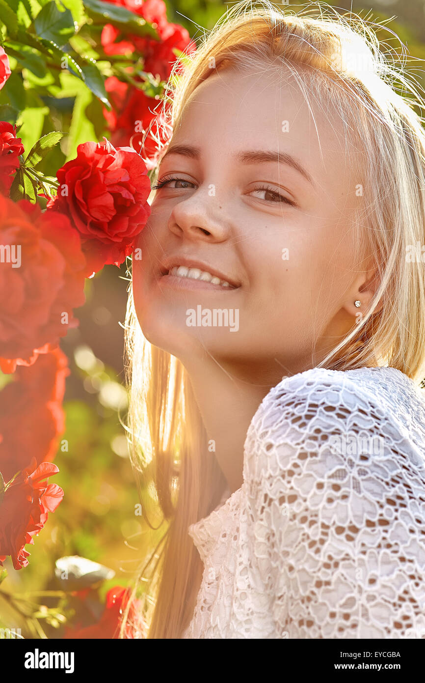 pretty happy girl smiling with flowers Stock Photo - Alamy
