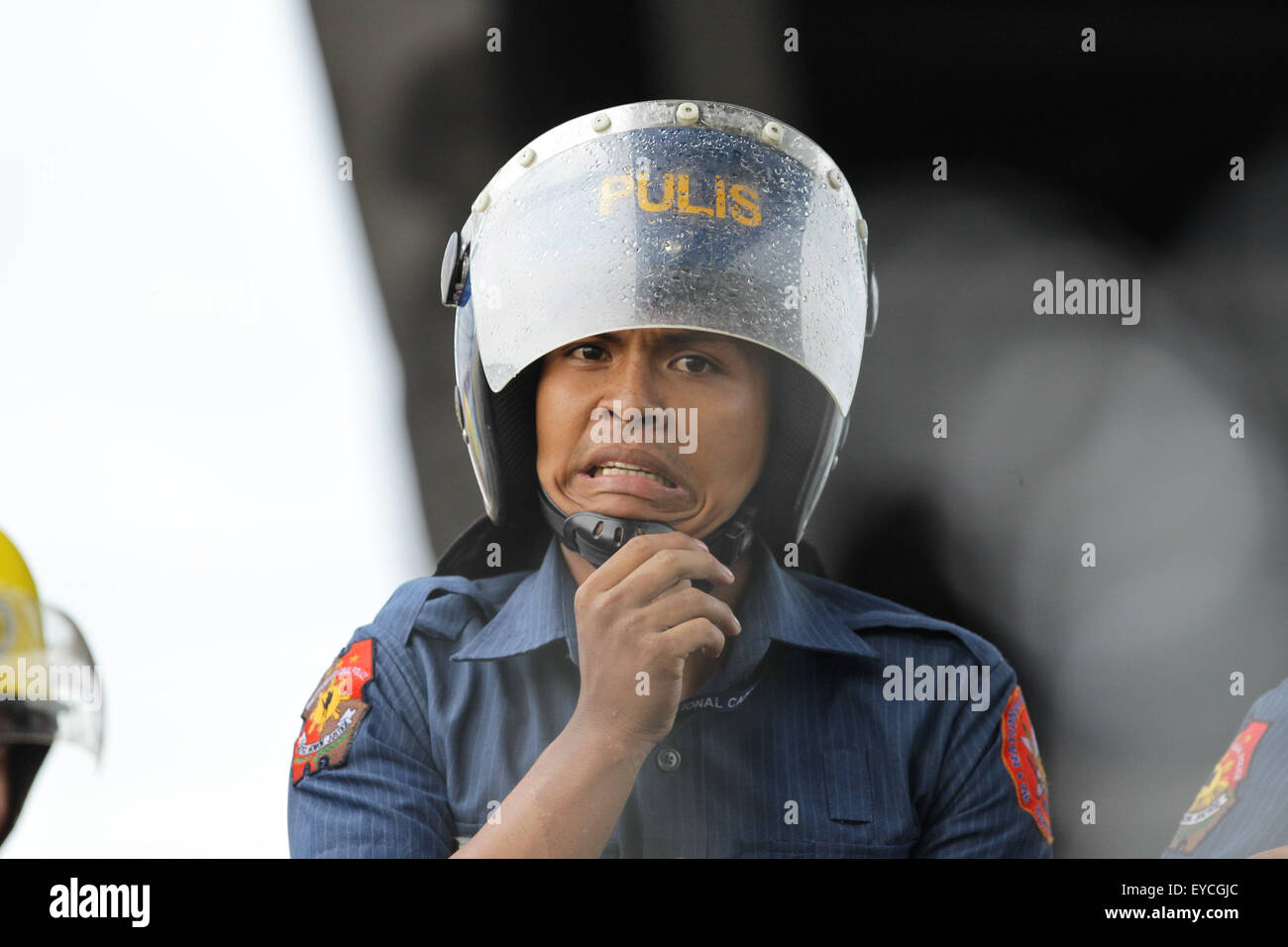 Quezon City, Philippines. 27th July, 2015. A riot police fixes his ...