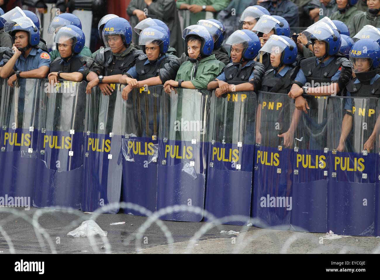 Quezon City, Philippines. 27th July, 2015. Riot police position a ...