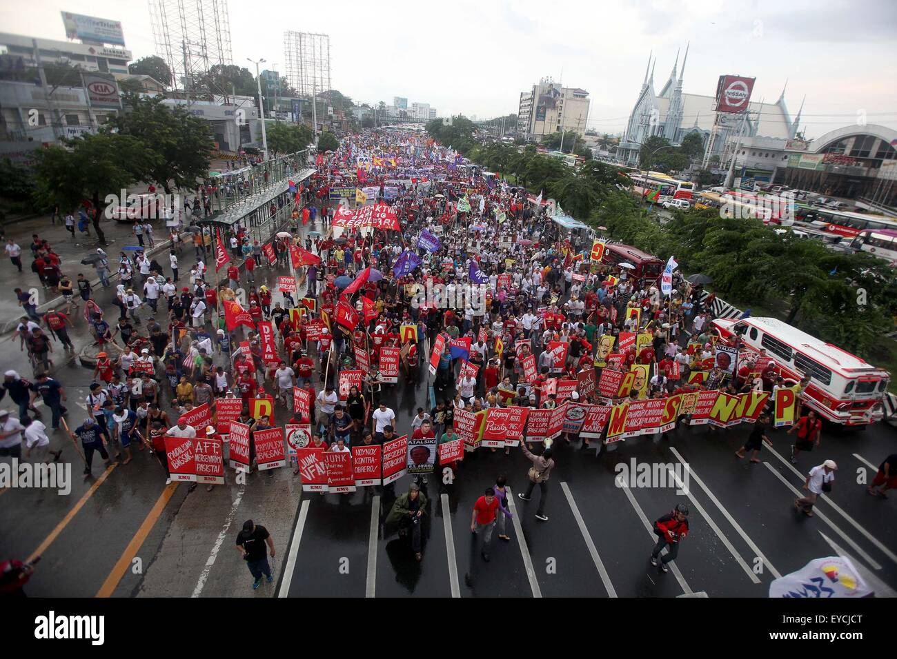 Quezon City, Philippines. 27th July, 2015. Activists walk in the rain ...