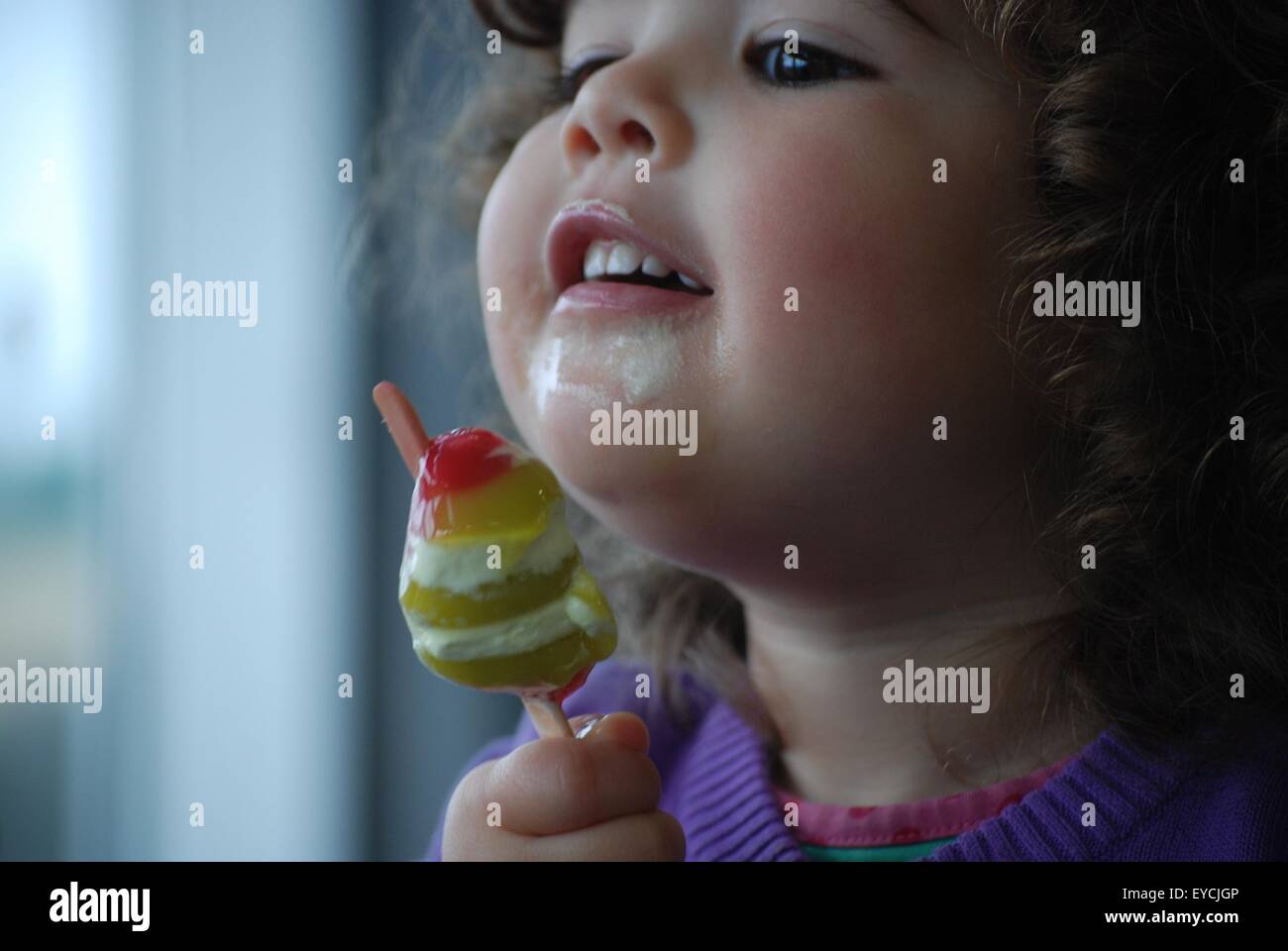 Child licking a lolly hi-res stock photography and images - Alamy