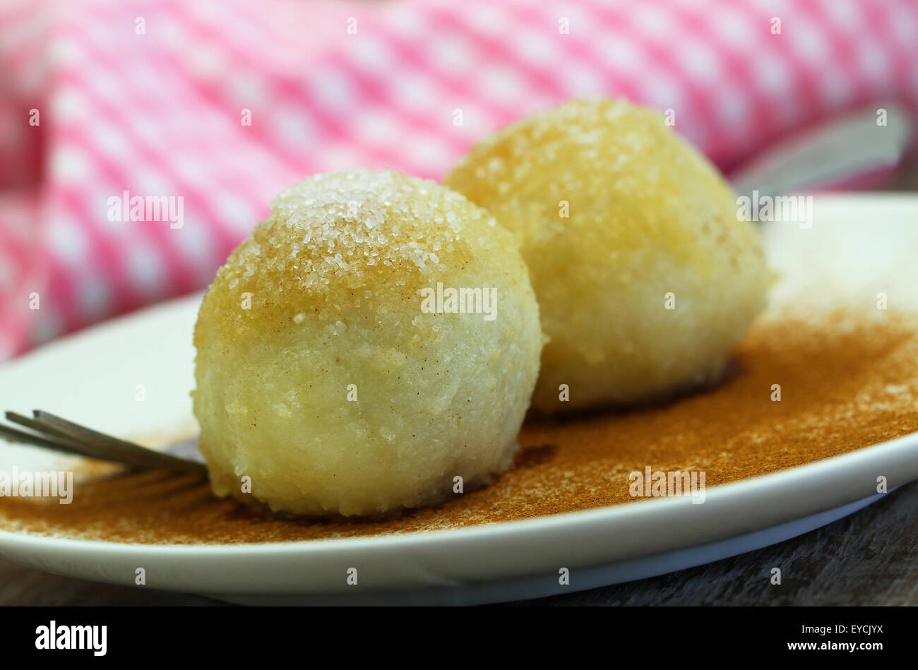 Sweet dumplings sprinkled with sugar and cinnamon, closeup Stock Photo ...