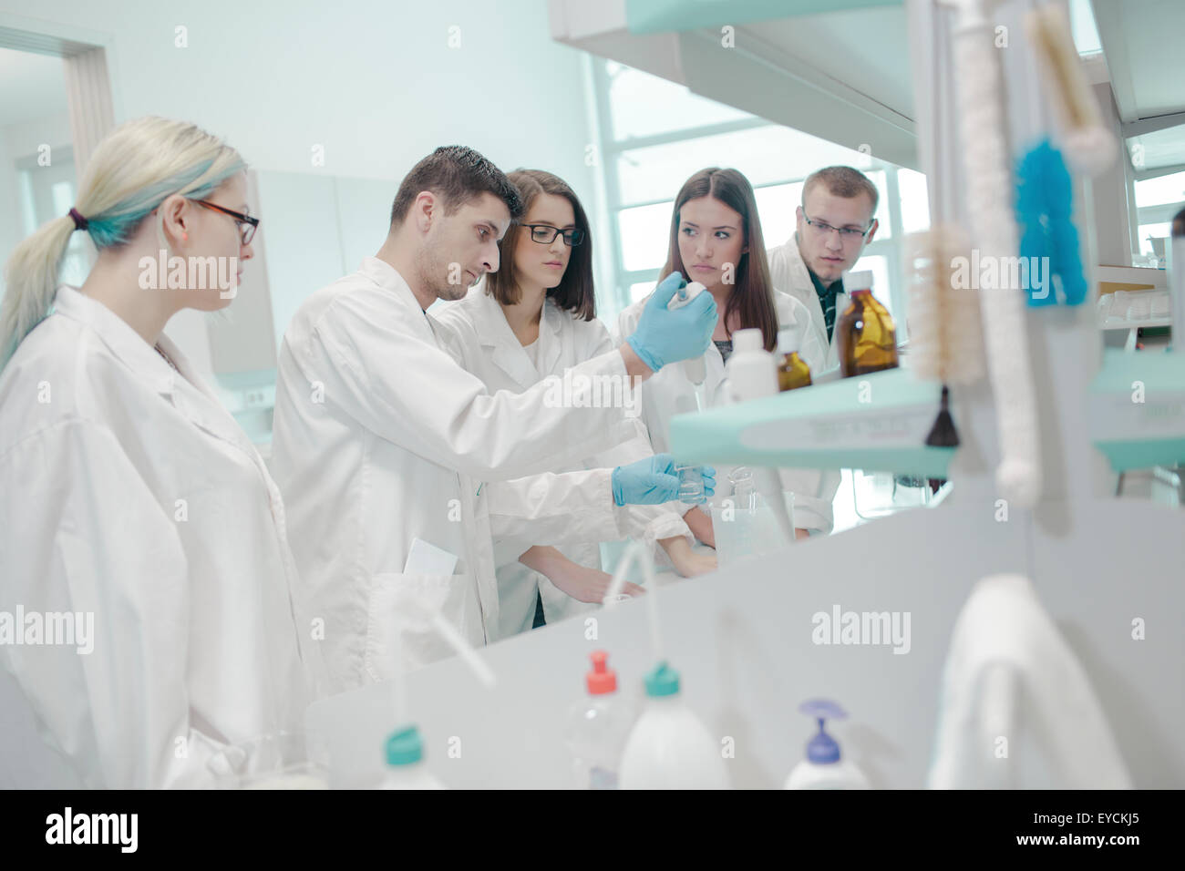 Scientists experimenting in lab Stock Photo - Alamy