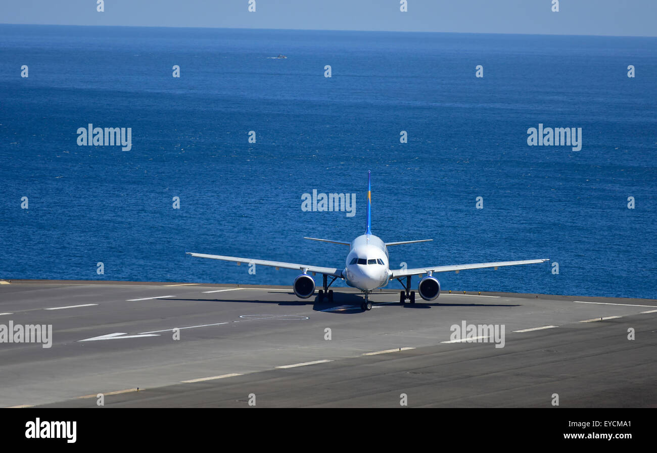 Portugal, Madeira, Airplane on runway, atlantic ocean in the background ...