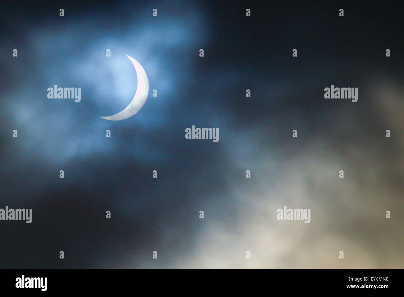 Partial solar eclipse, through the clouds, seen in the UK on Friday ...