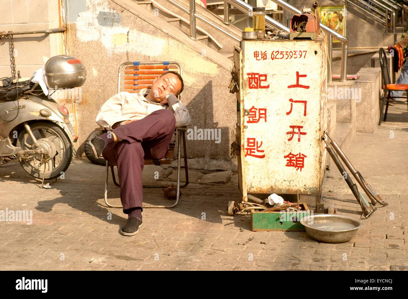 Asian man sleeping in chair hi-res stock photography and images - Alamy