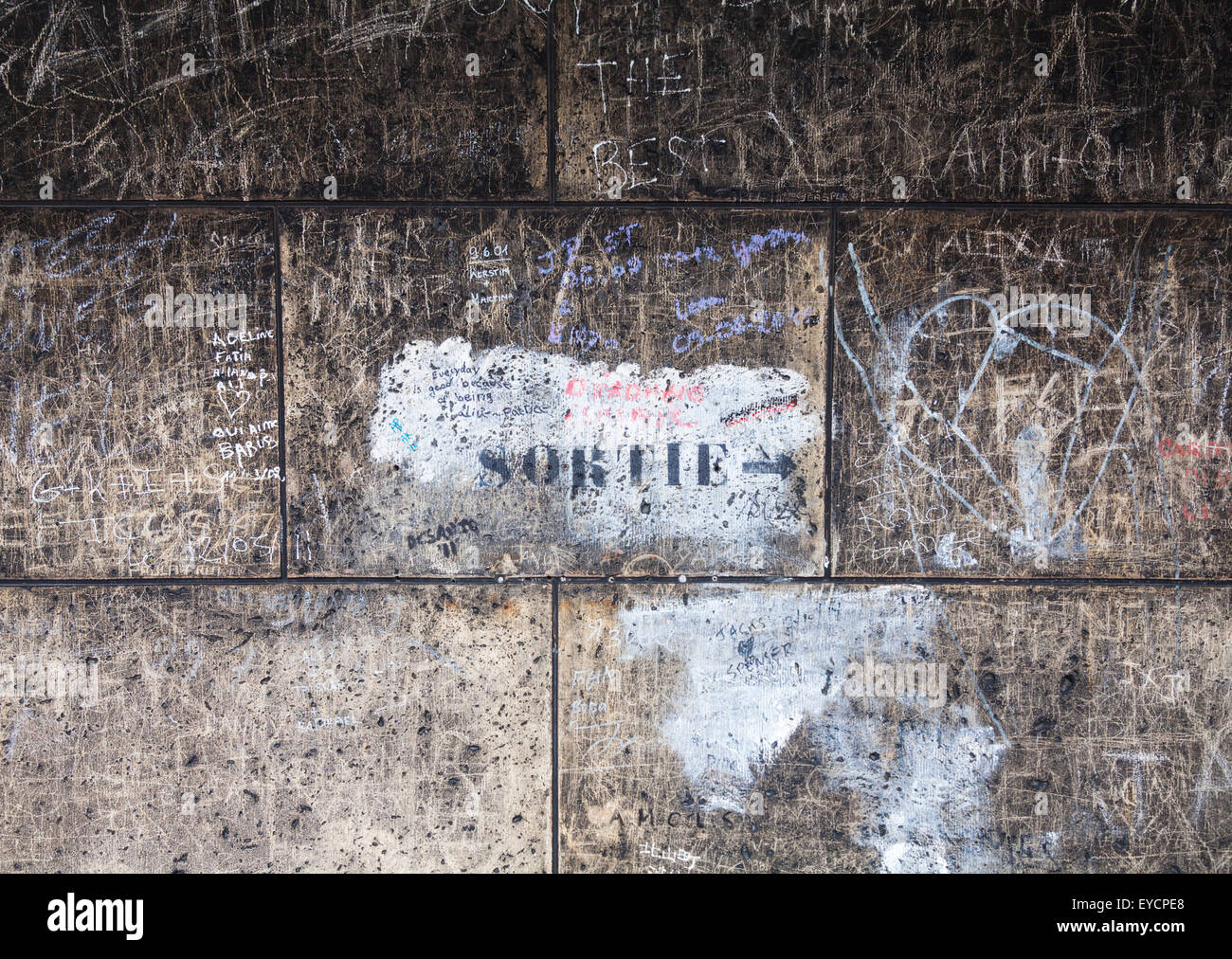 Sortie exit sign and scribbles carved into travertine stone walls in ...