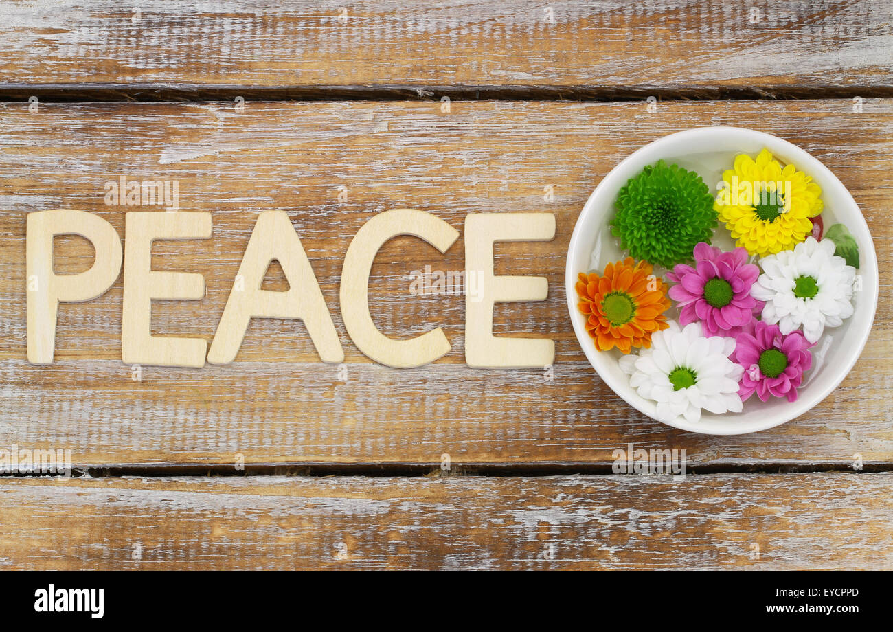 Peace written with wooden letters on rustic wood and colorful Santini ...
