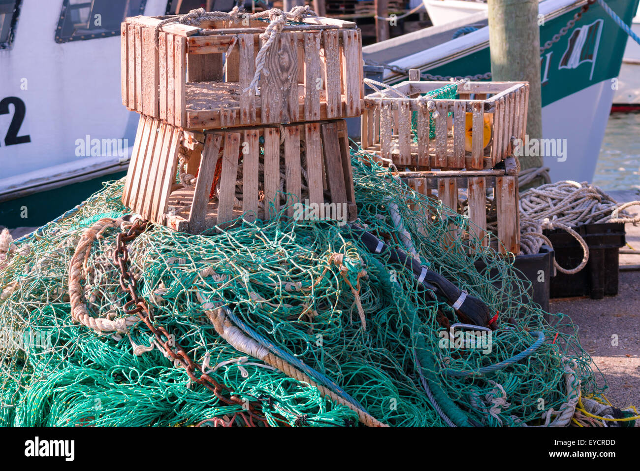 Fishing traps and nets fill this photo with a commercial fishing vessel ...