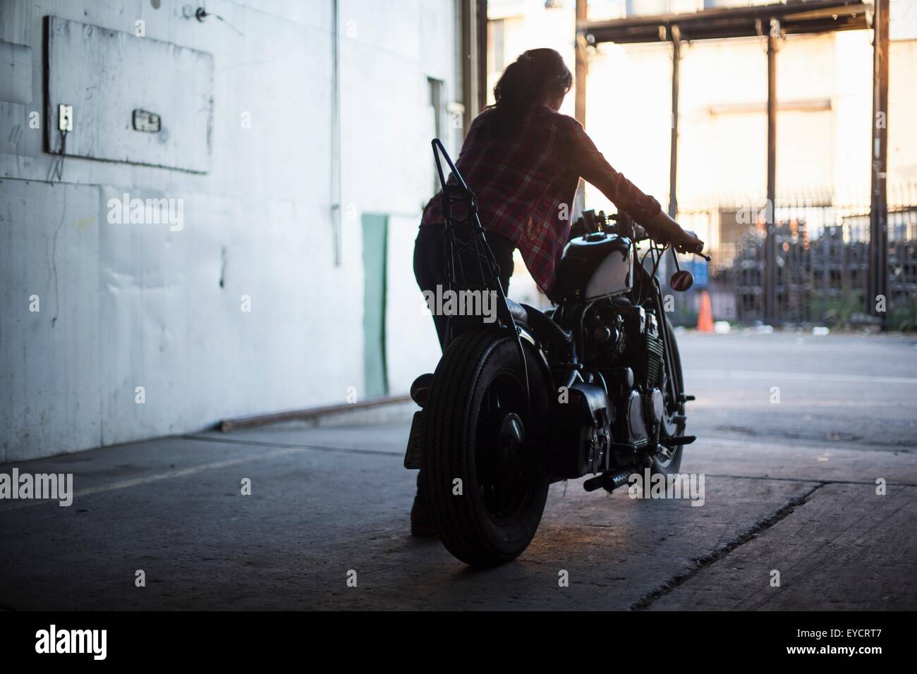 Female mechanic working on motorcycle in workshop Stock Photo - Alamy