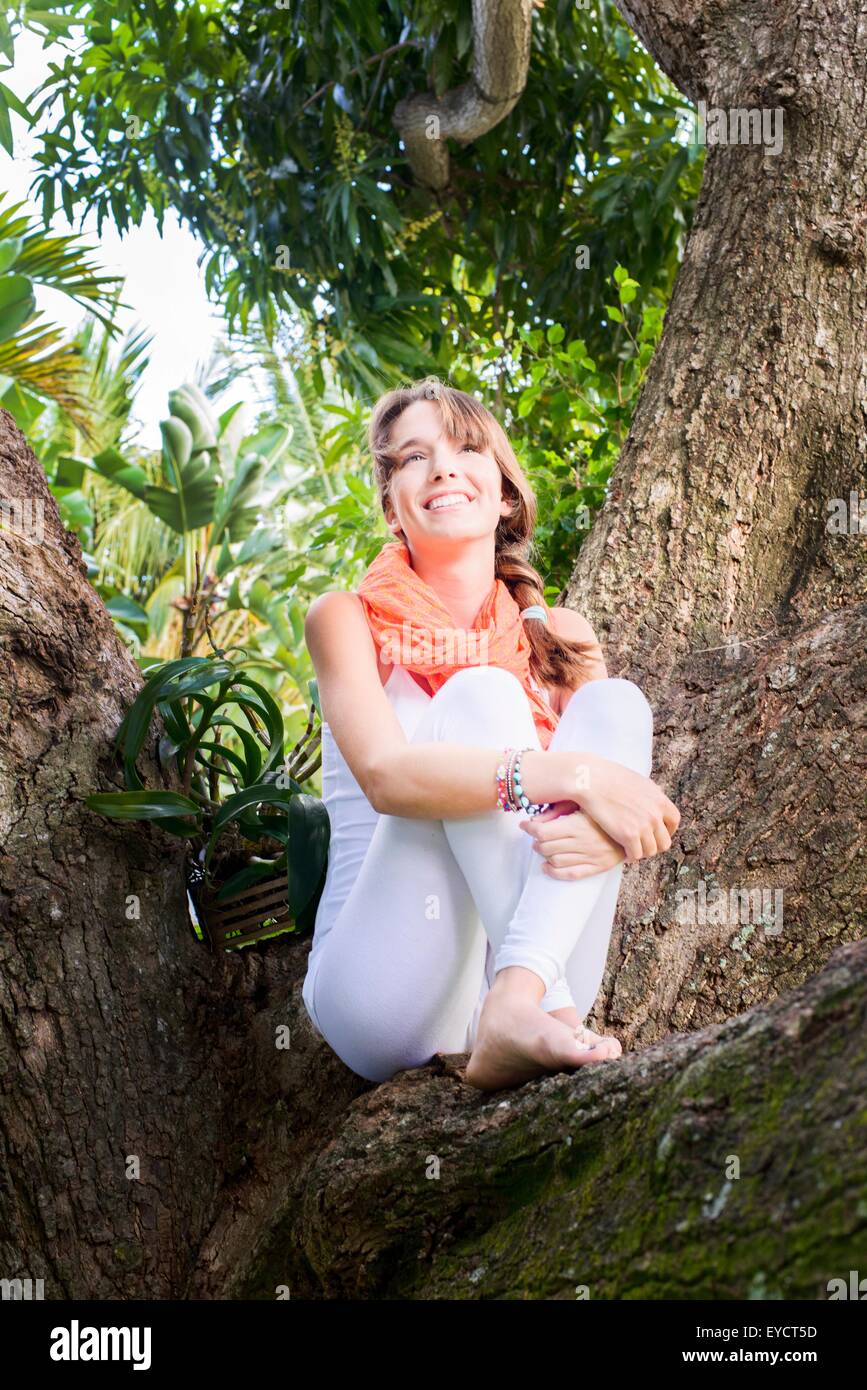 Woman climbing tree hi-res stock photography and images - Alamy