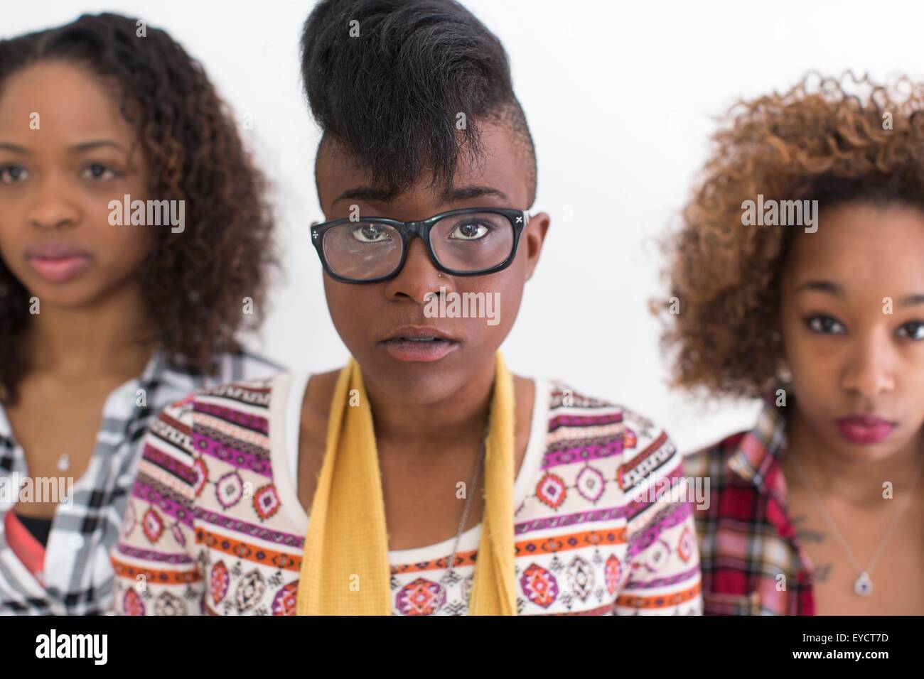 Studio portrait of three serious staring young women friends Stock ...