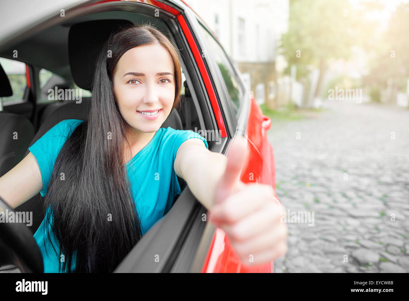Happy smiling girl in a red car Stock Photo - Alamy