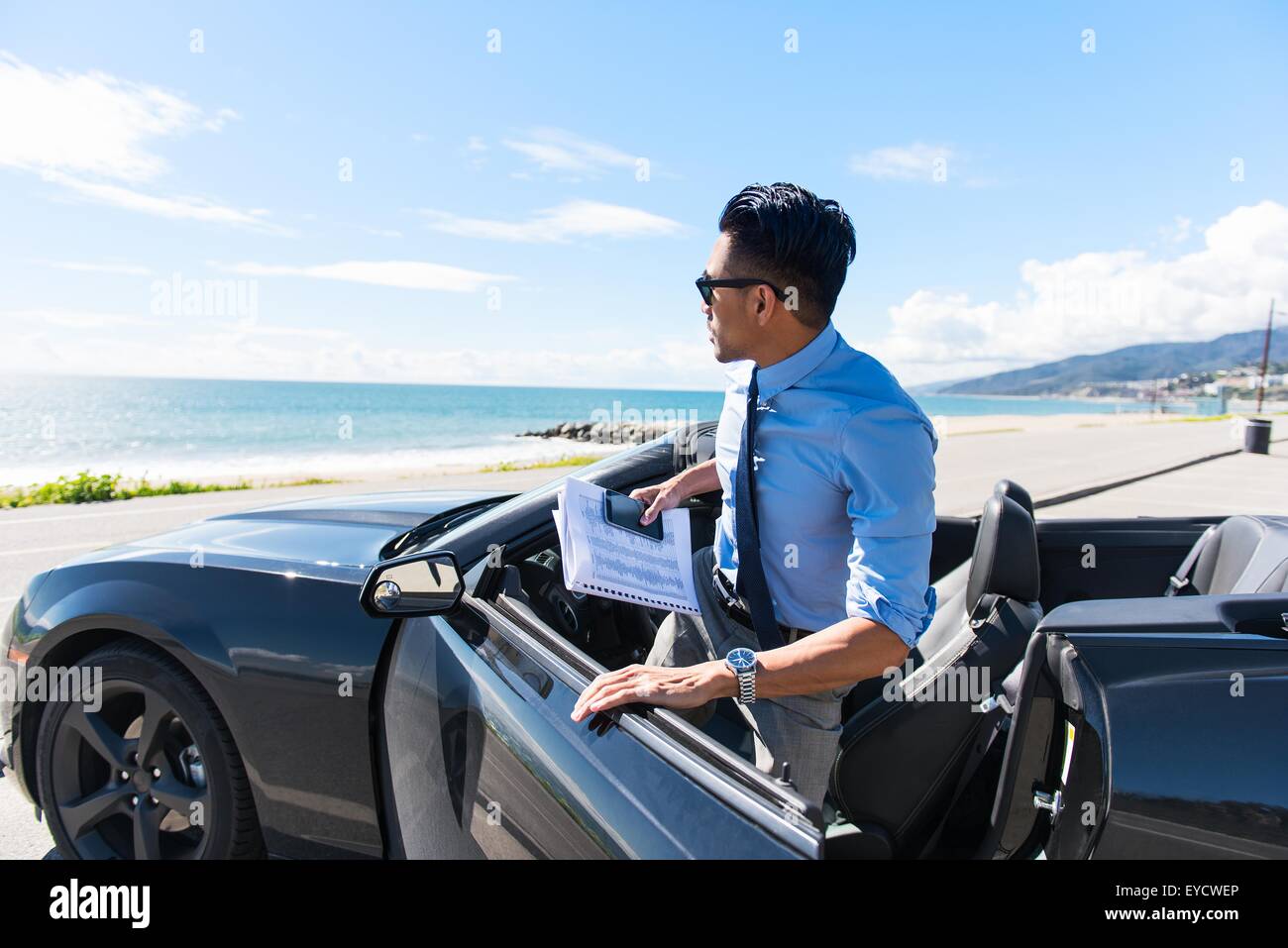 Young businessman getting out car hi-res stock photography and images ...