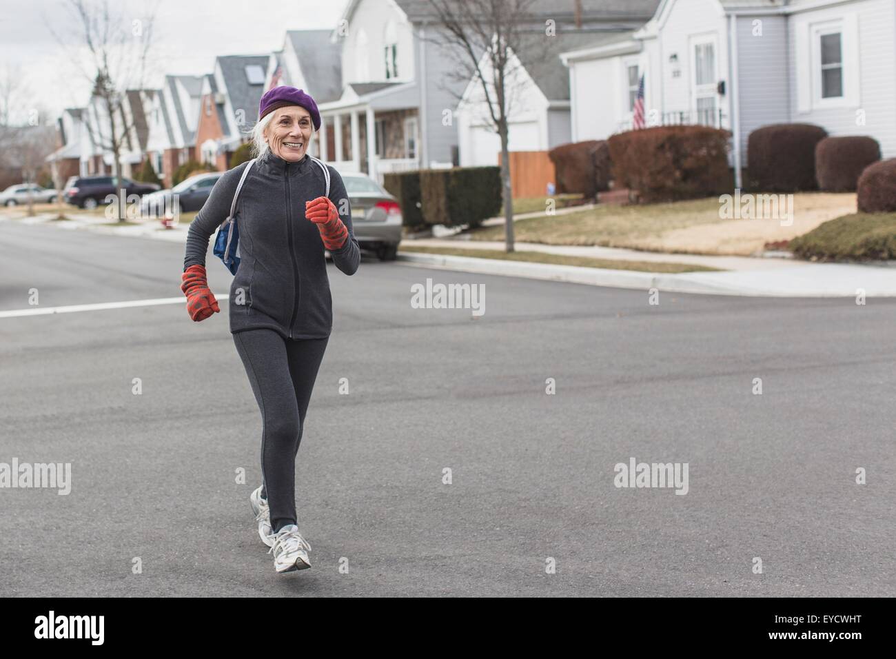 Senior woman jogging in street Stock Photo - Alamy